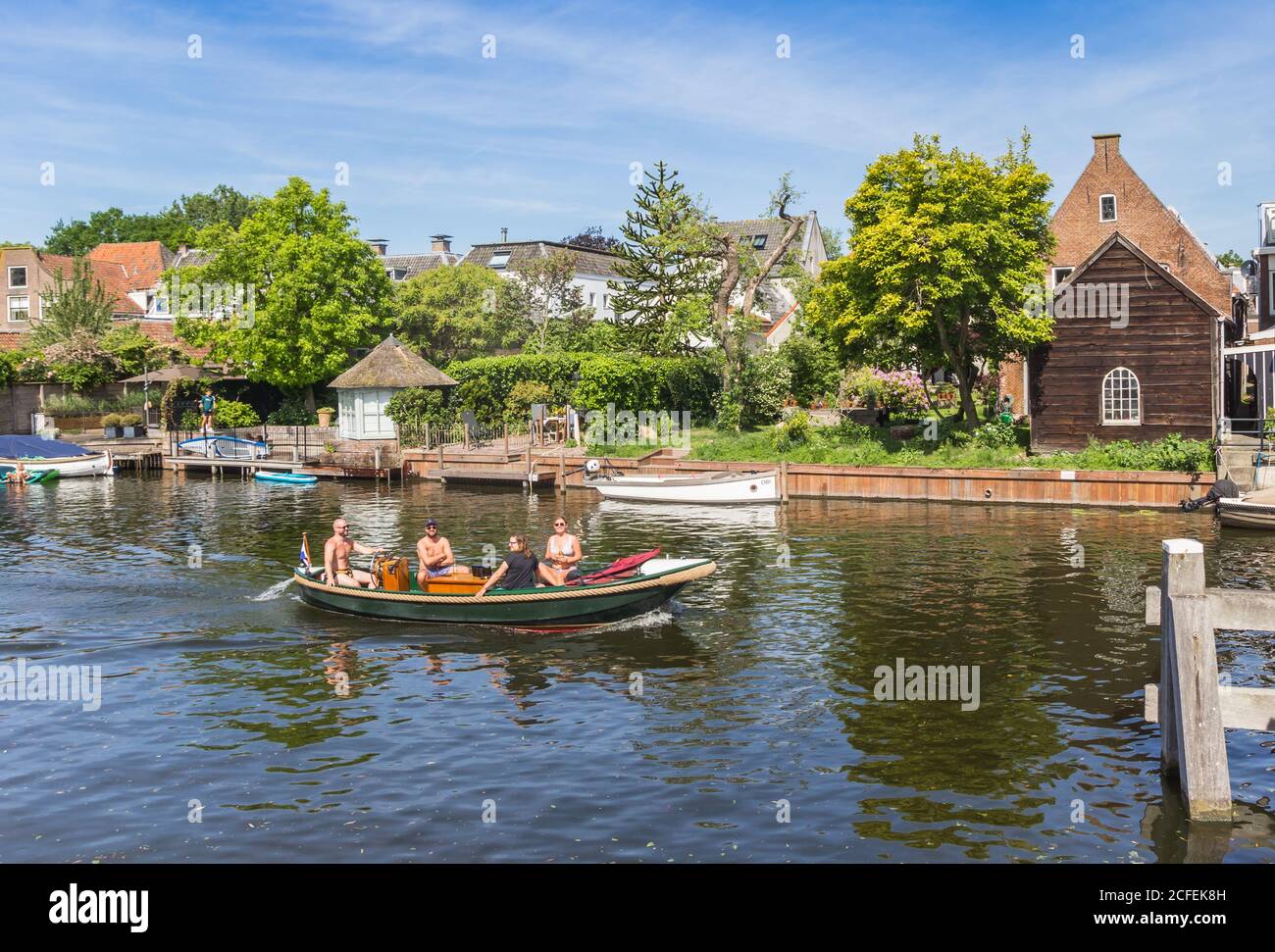 Tourists taking a boat ride on the river Vecht in Loenen, Netherlands ...