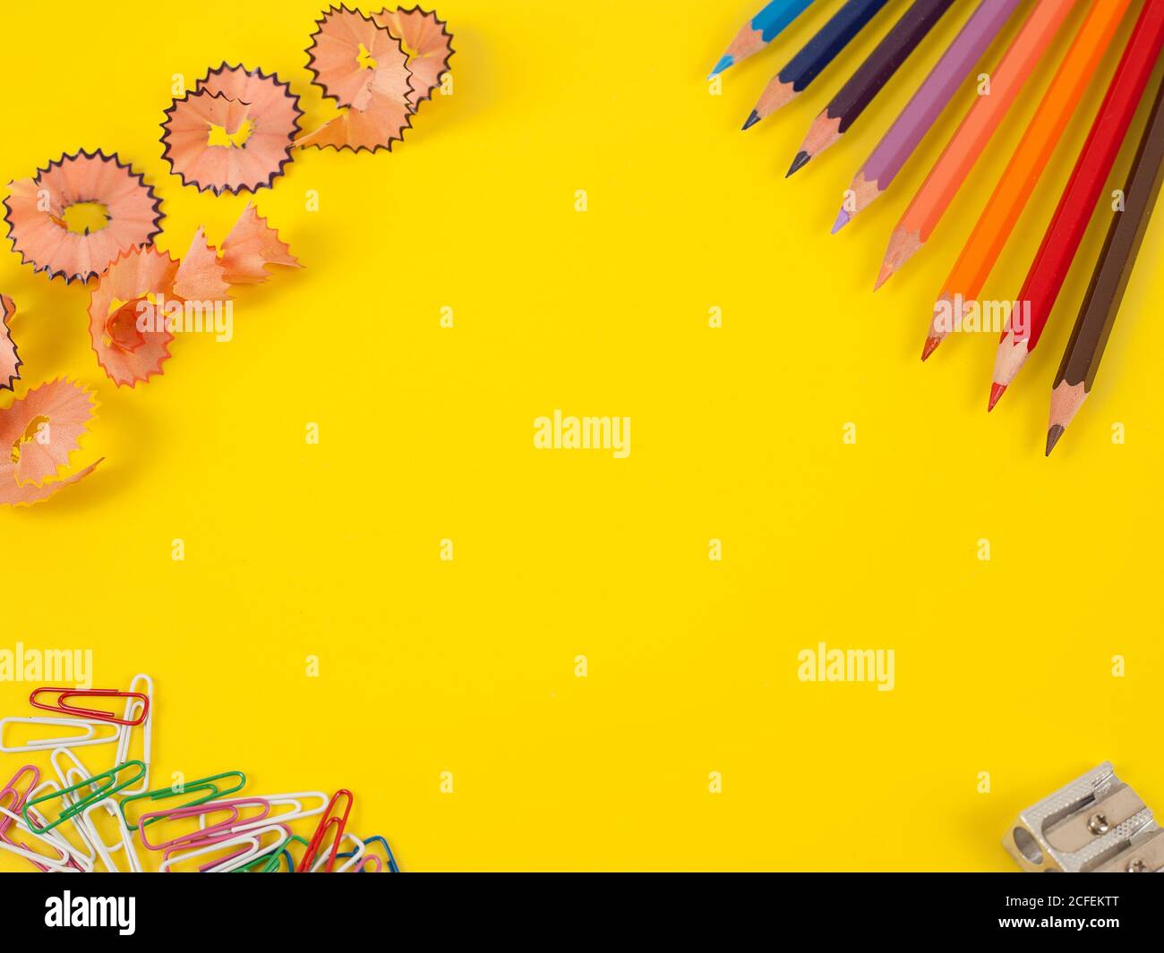 Some colored pencils of different colors and a pencil sharpener and ...