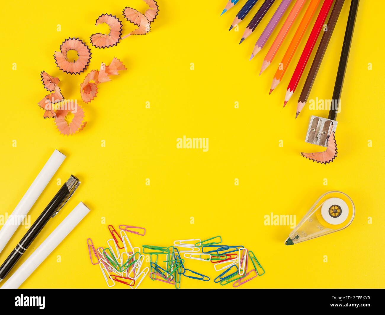 Some colored pencils of different colors and a pencil sharpener and ...