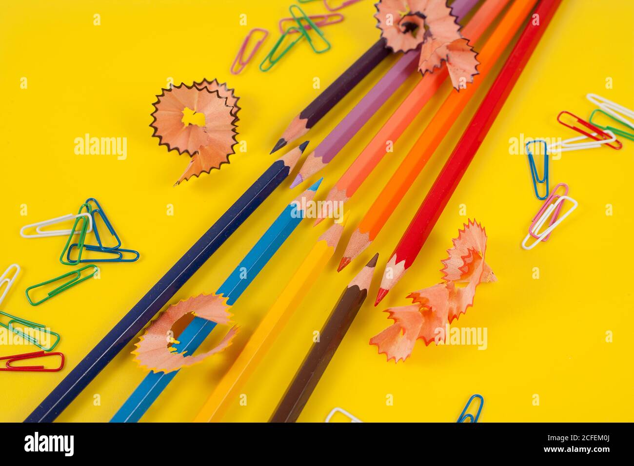 Some colored pencils of different colors and a pencil sharpener and ...