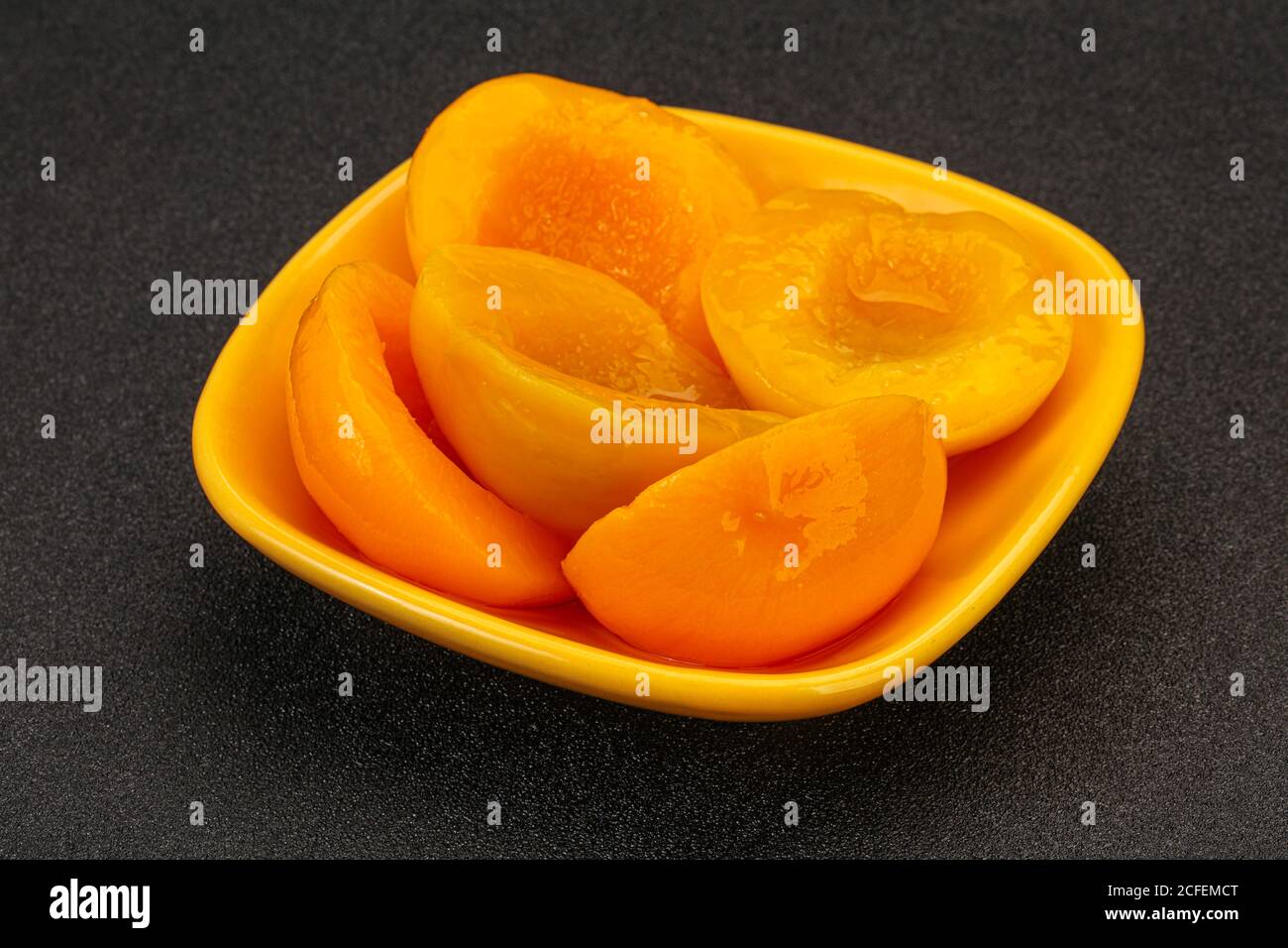 Marinated peaches fruit in the bowl with syrope Stock Photo - Alamy