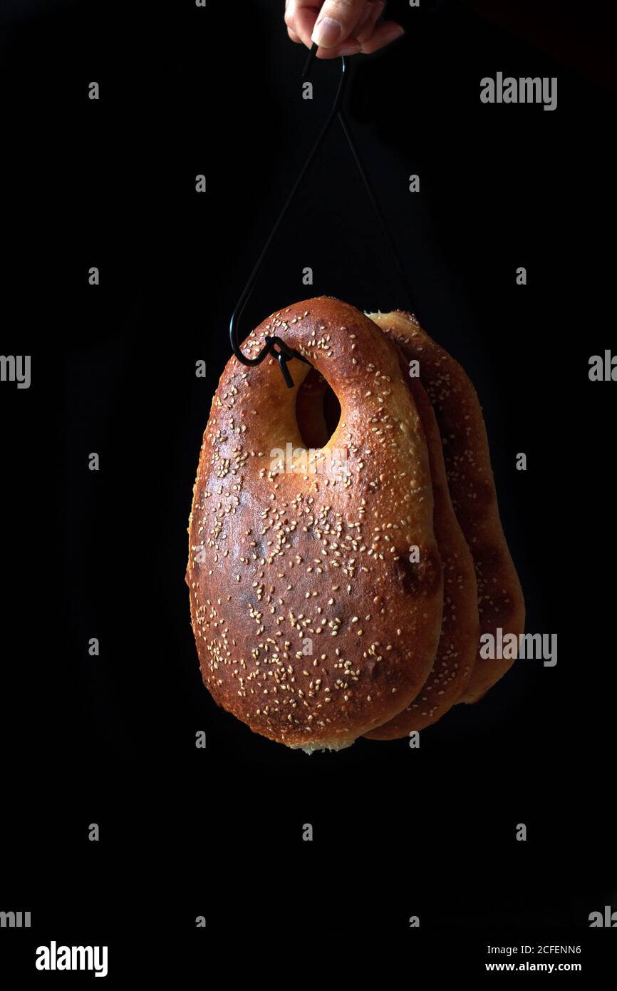 unrecognizable person holding hook with bunch of fresh Middle Eastern ...