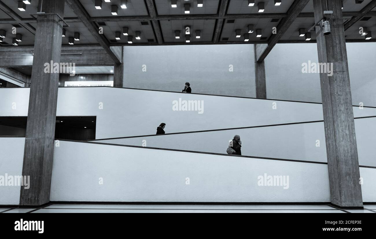 3 people are positioned perfectly on an architectural diagonal paths ...