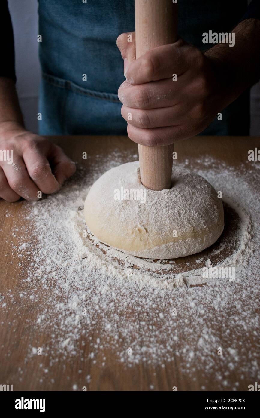 unrecognizable cook shaping fresh dough with flour while cooking Rosca ...