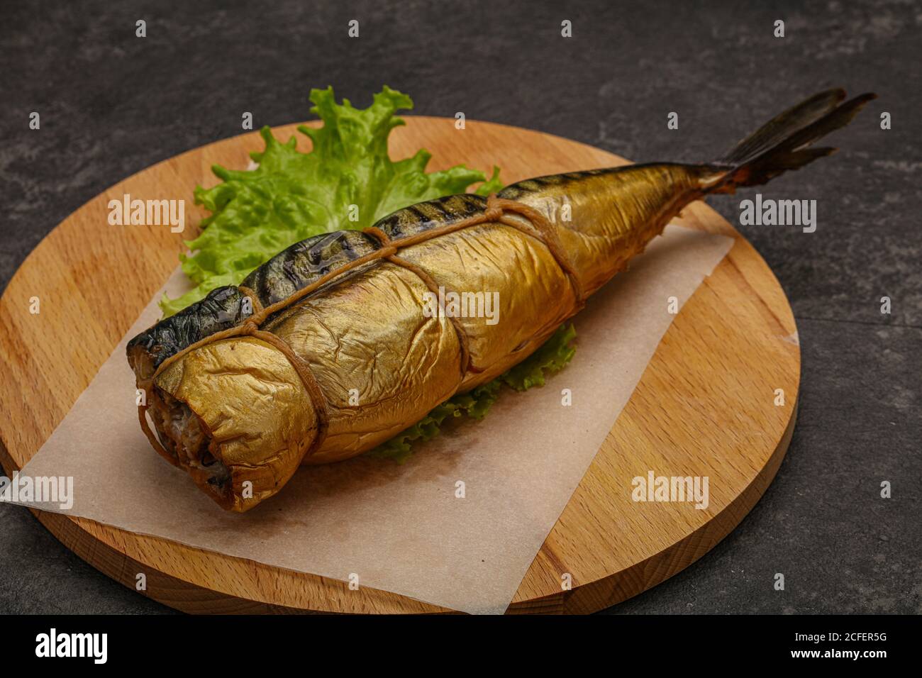 Smoked tasty mackerel fish snack over board Stock Photo - Alamy