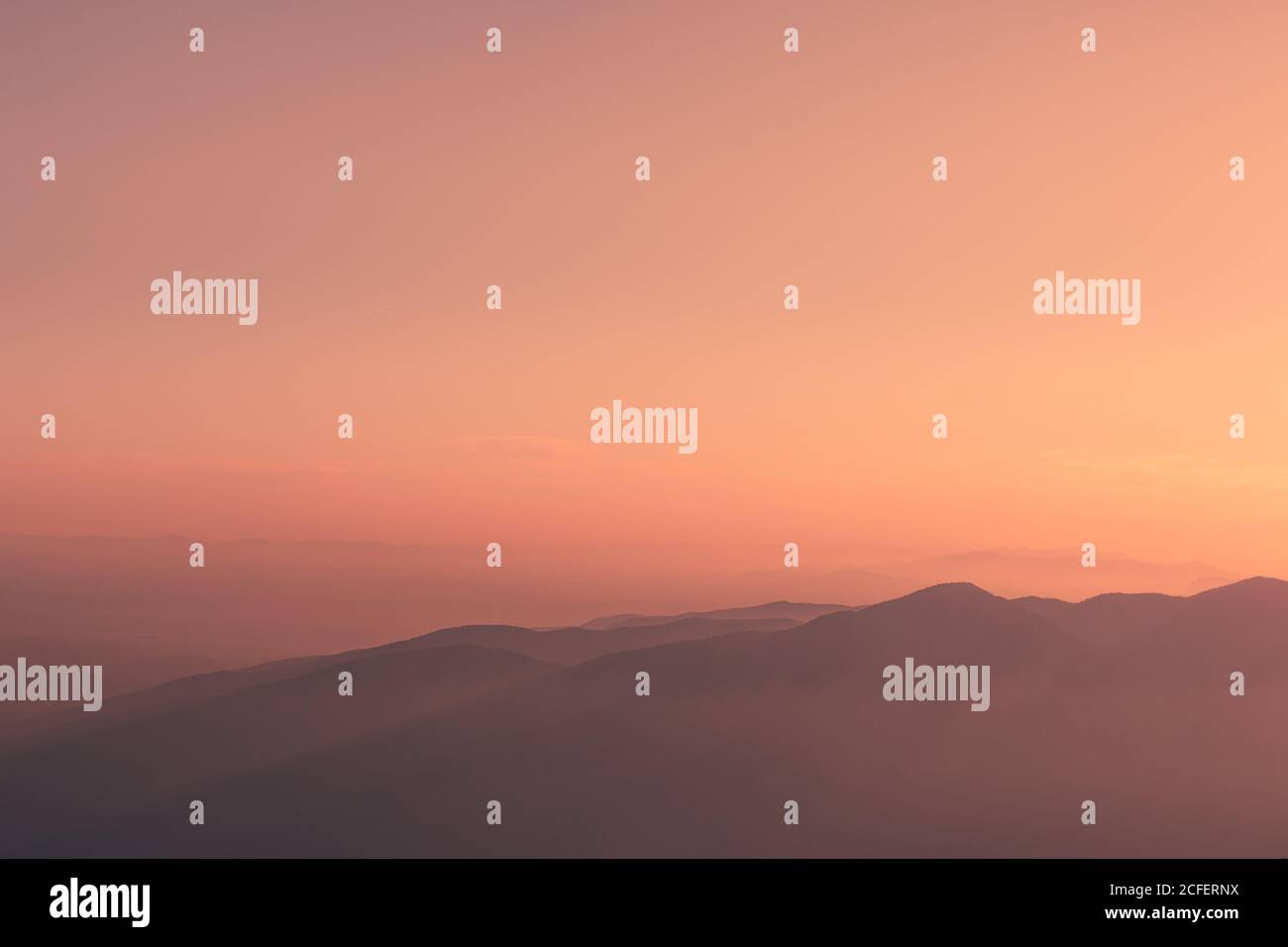 Sunset sky over mountain ridge Stock Photo - Alamy