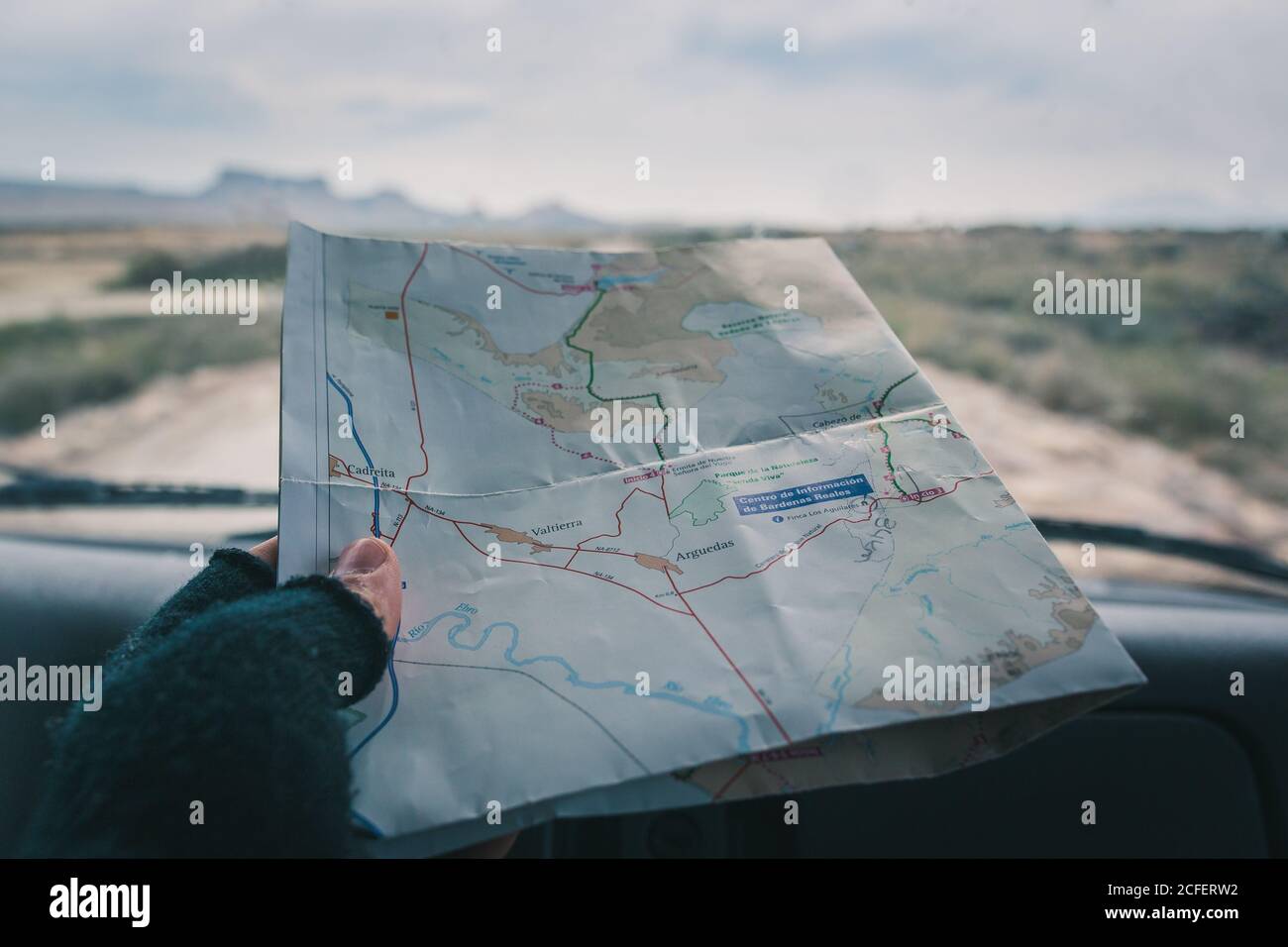 Man in car studying road map driving on road Stock Photo - Alamy
