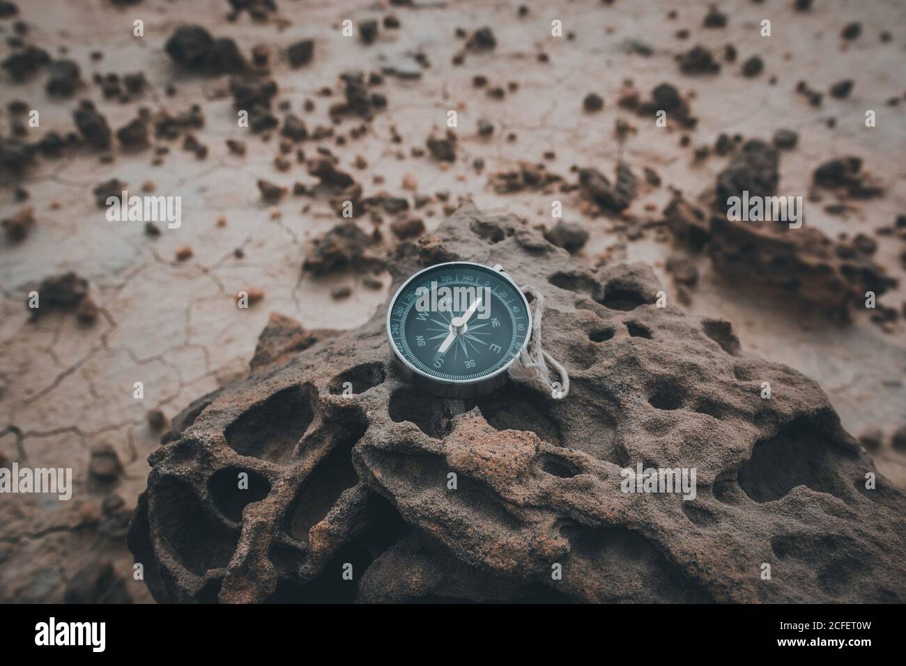 Big compass on dry cracked desert area Stock Photo - Alamy