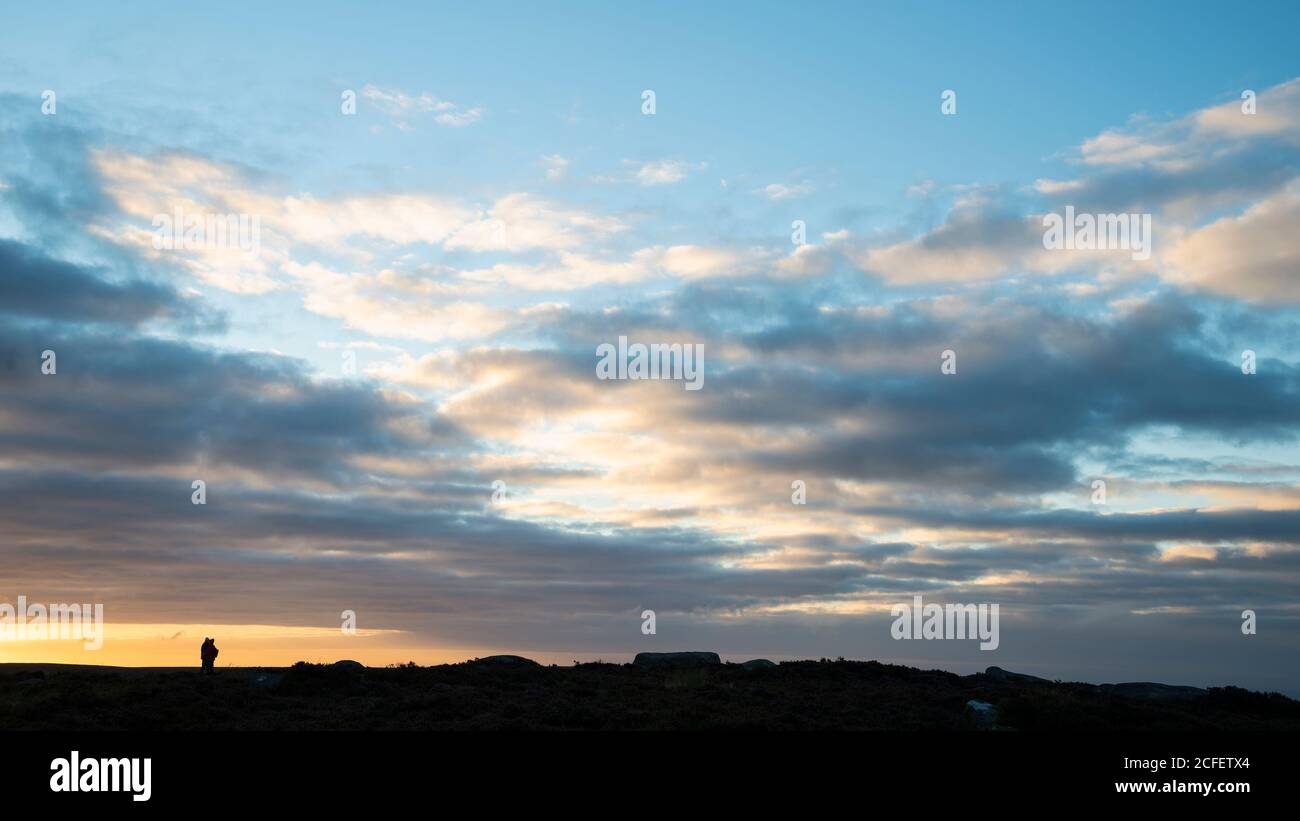 Conceptual image of isolation and remoteness with two people silhoutted ...