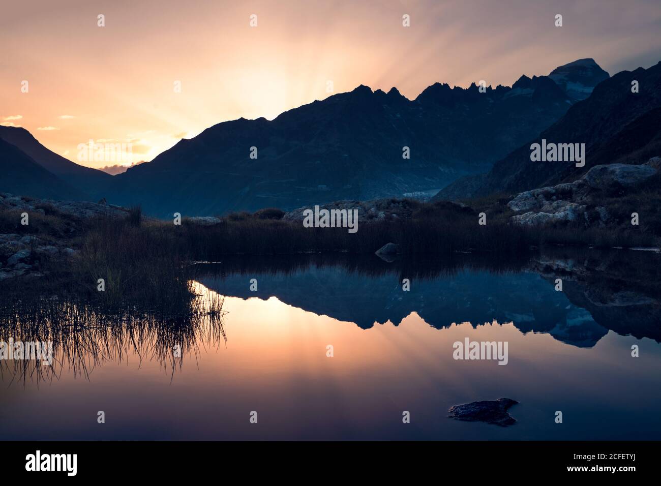 Breathtaking landscape of motionless water reflecting sky in warm ...