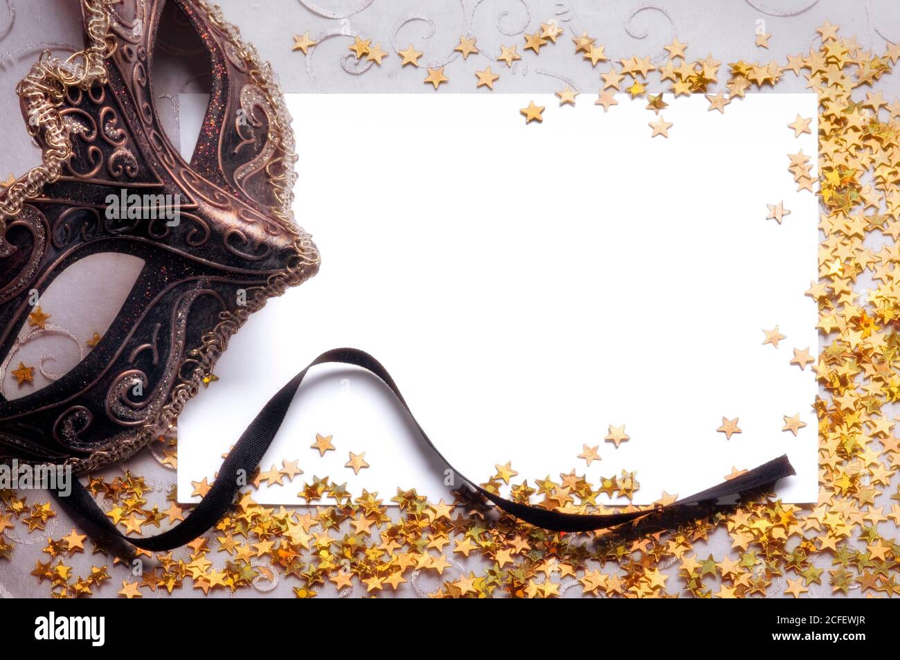 Carnival mask party still life with blank paper for text Stock Photo ...