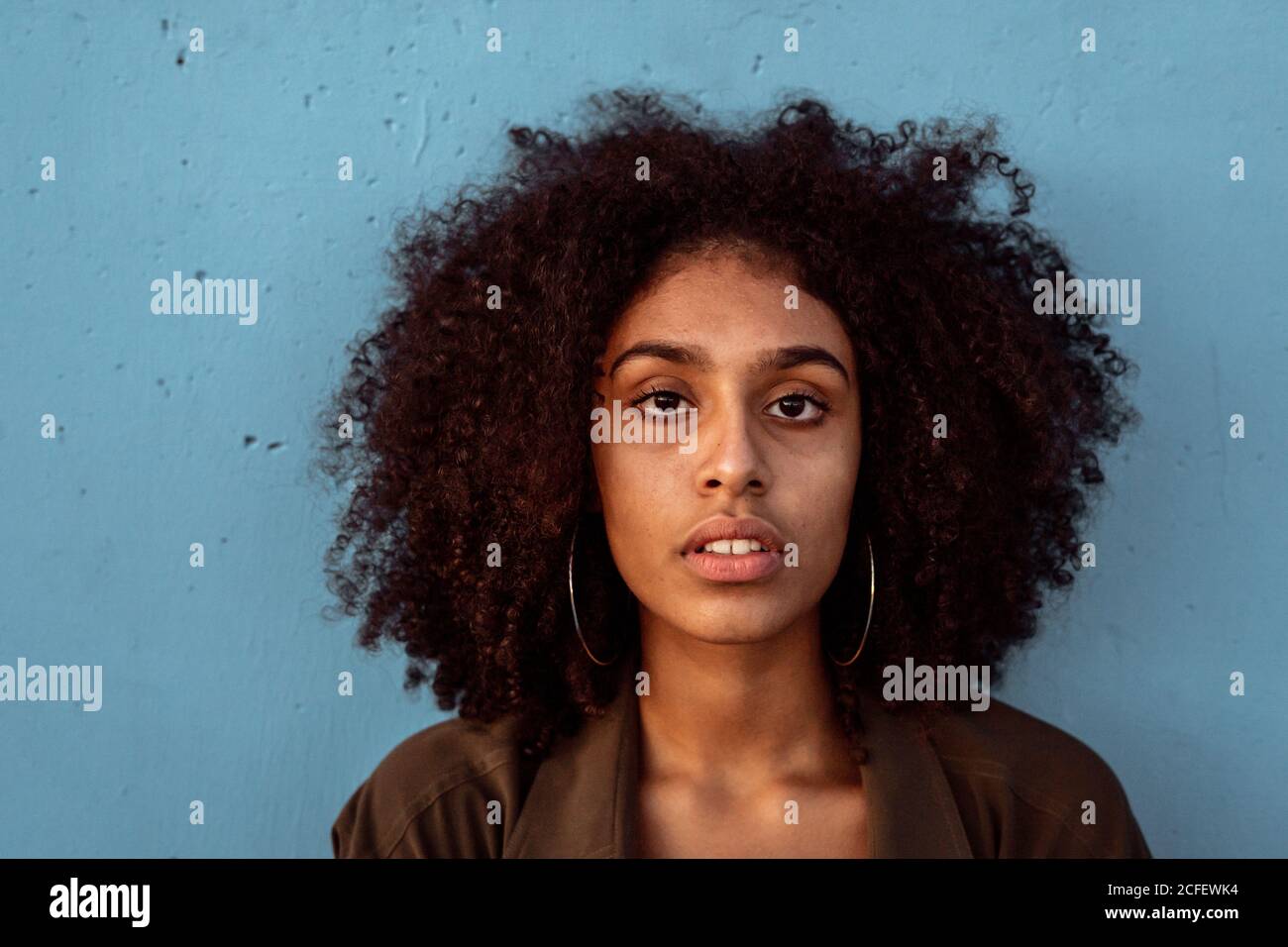 Young black Woman looking at camera with intense look Stock Photo - Alamy
