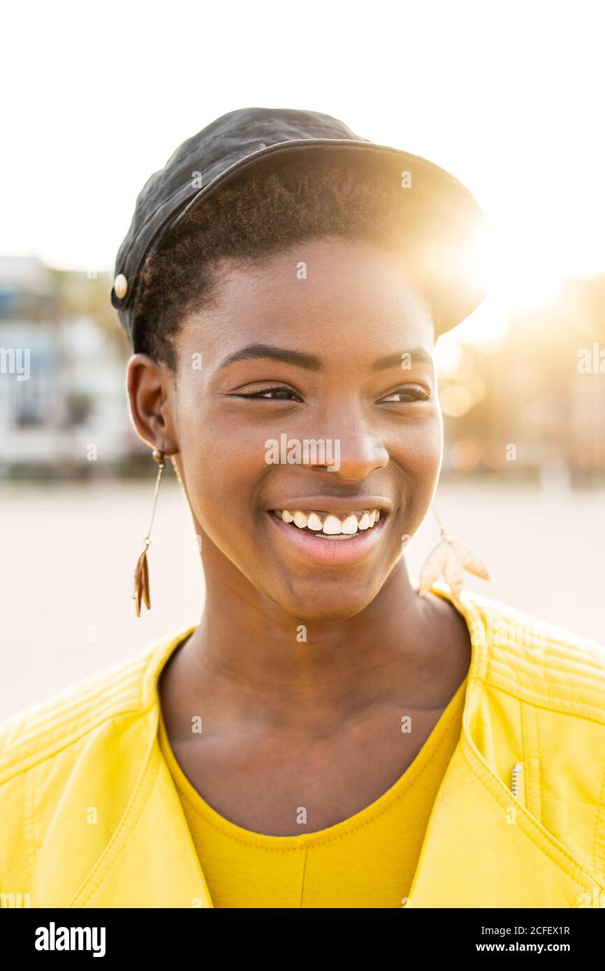 Portrait of happy African American Woman in stylish bright jacket ...