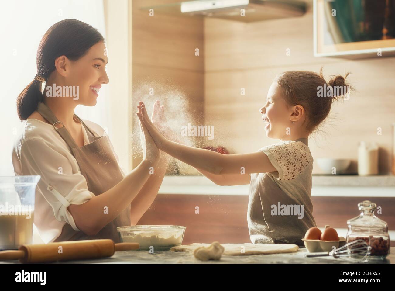 Happy loving family are preparing bakery together. Mother and child ...