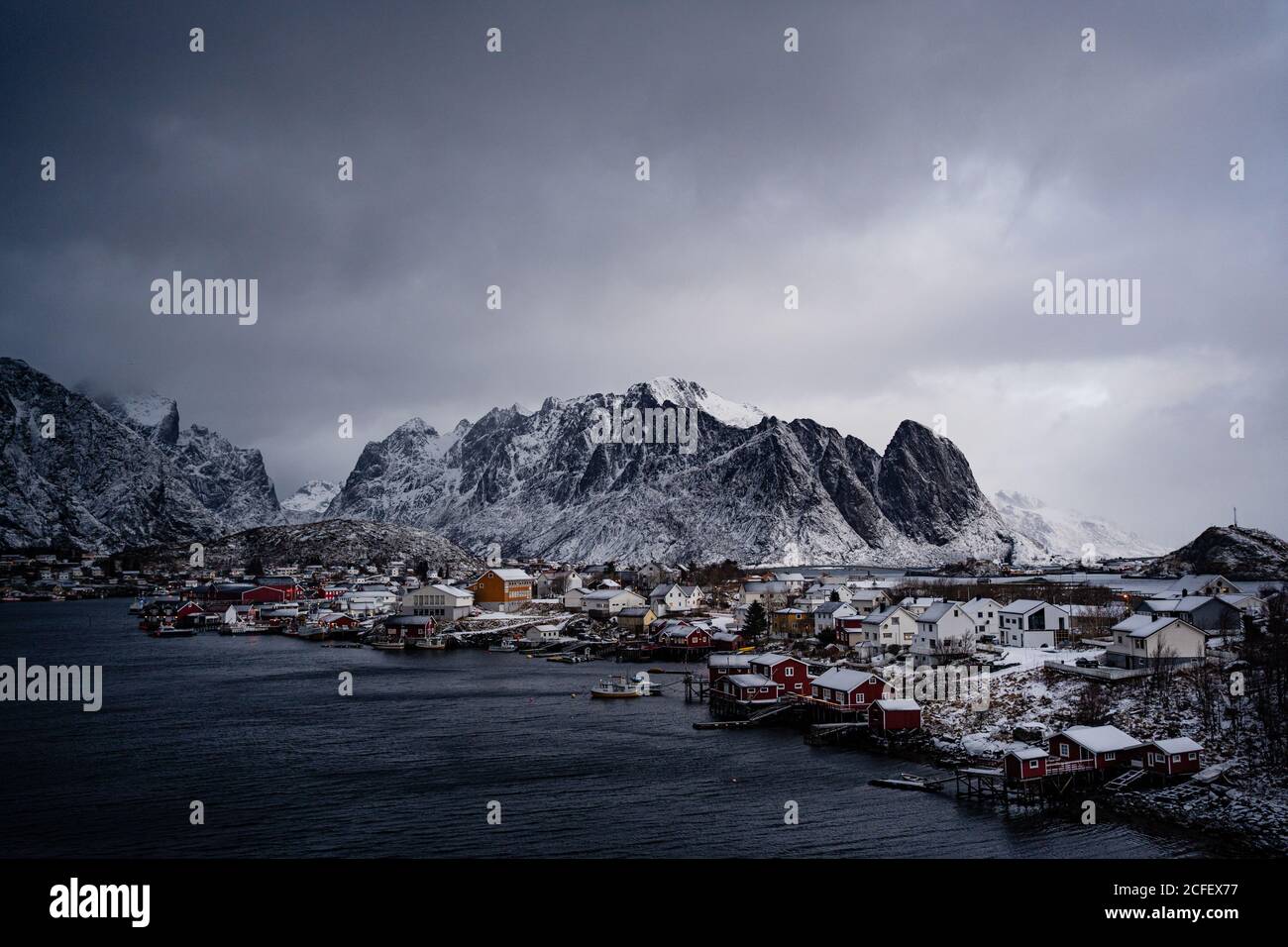 From above of city harbor against snowy mountain ridges at horizon in ...
