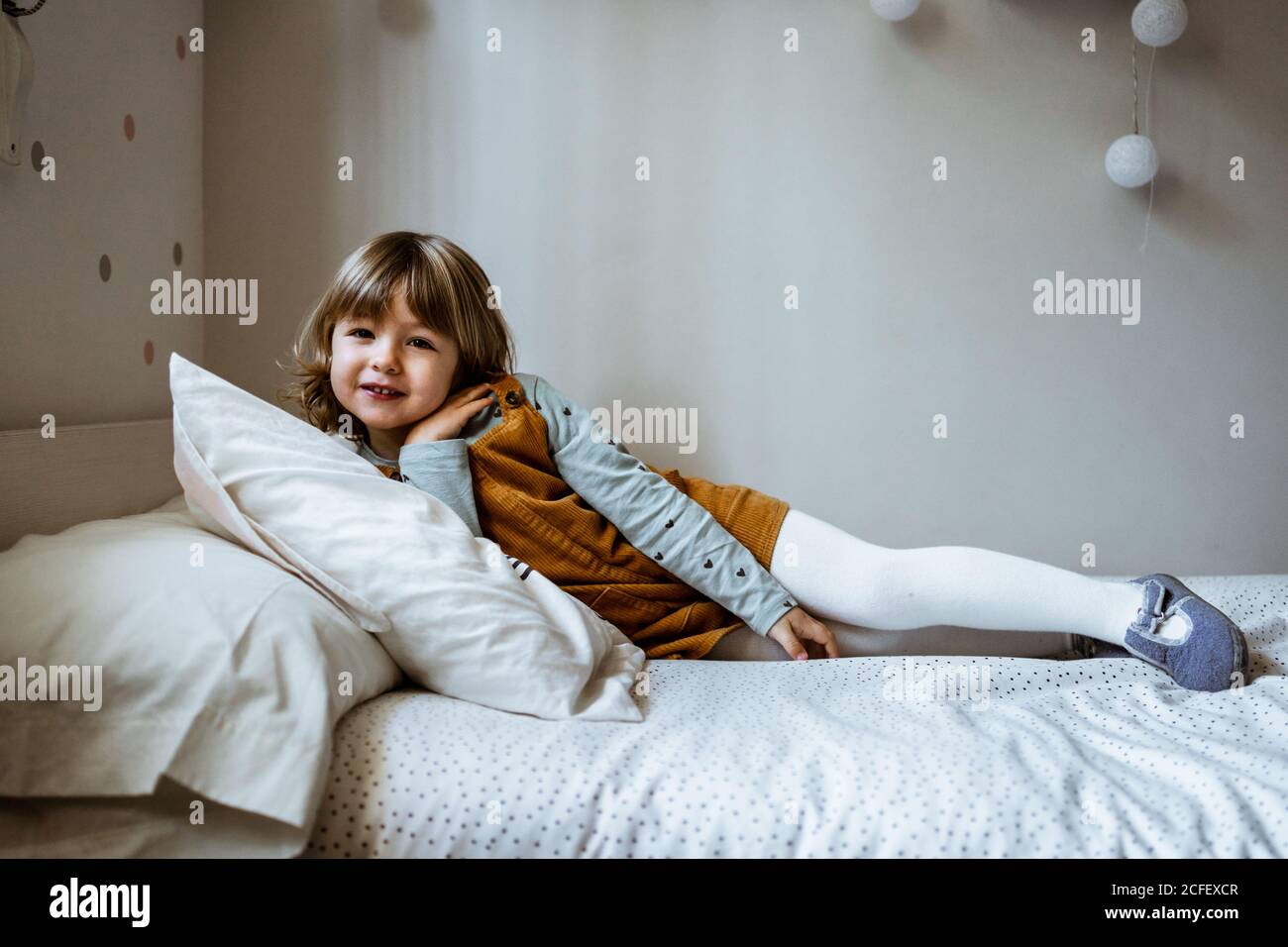 Cute girl looking at camera Stock Photo - Alamy
