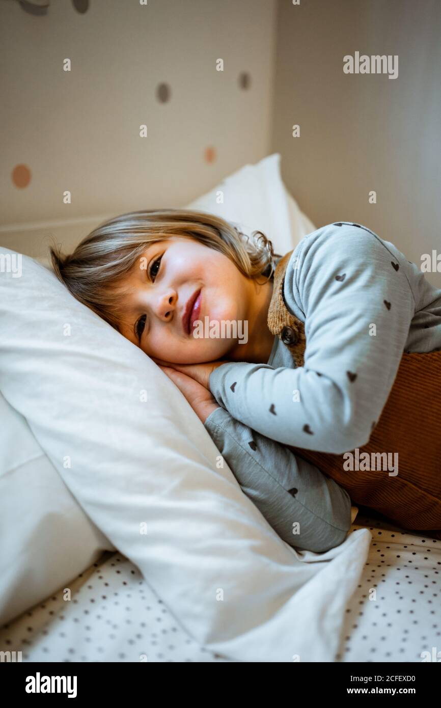 Cute girl looking at camera Stock Photo - Alamy