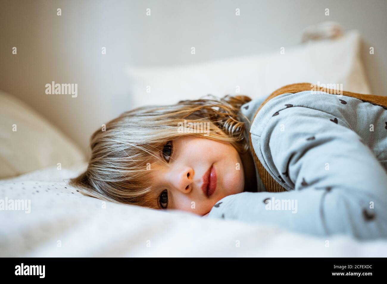 Cute girl looking at camera Stock Photo - Alamy