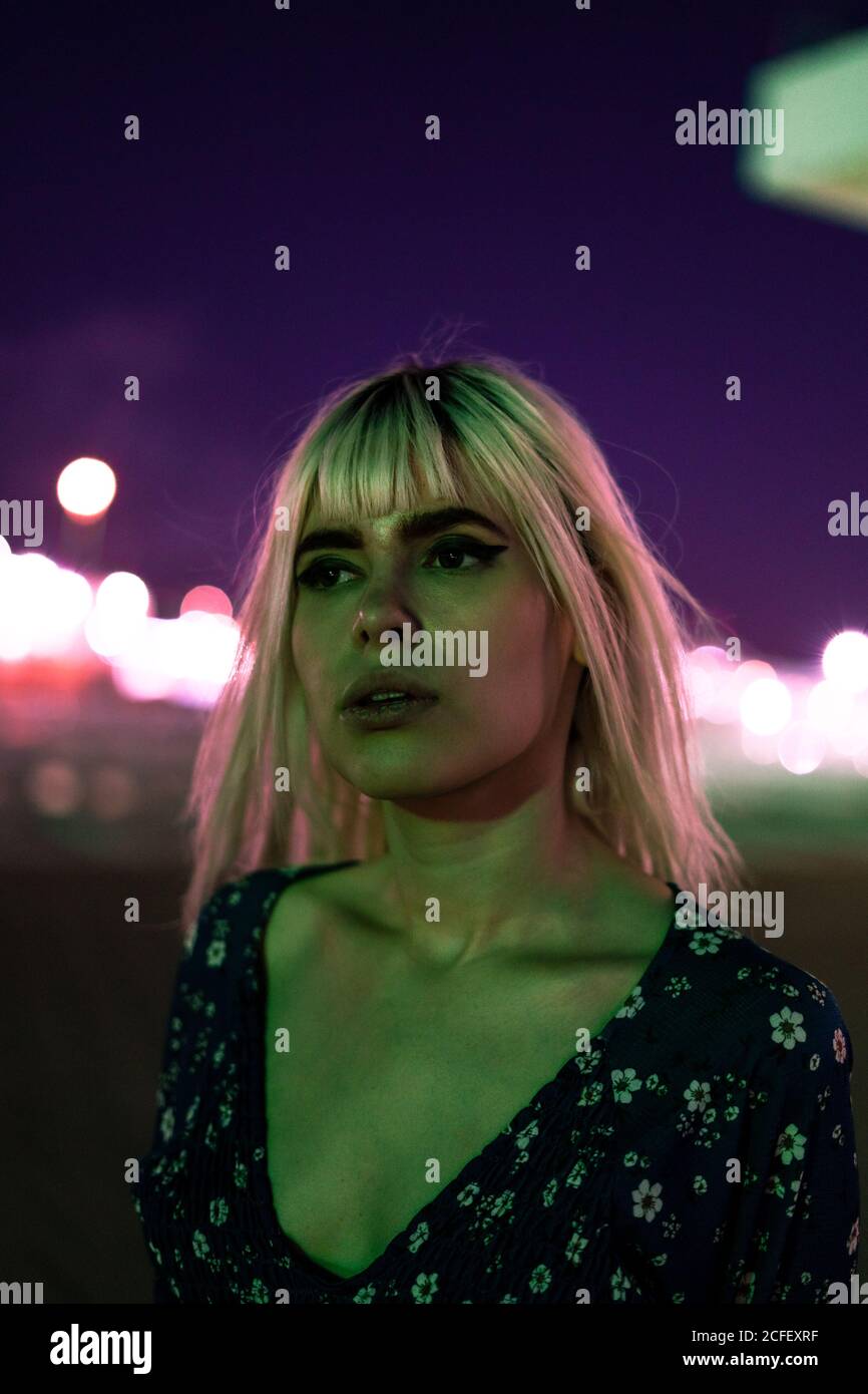 Attractive confident blond female with dark eyebrows in oversize ...