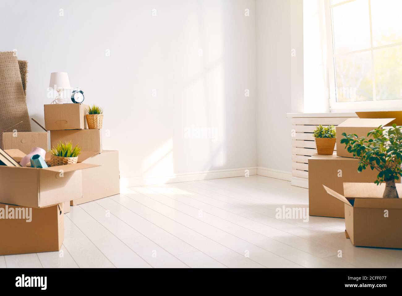 Cardboard boxes in empty new apartment Stock Photo - Alamy