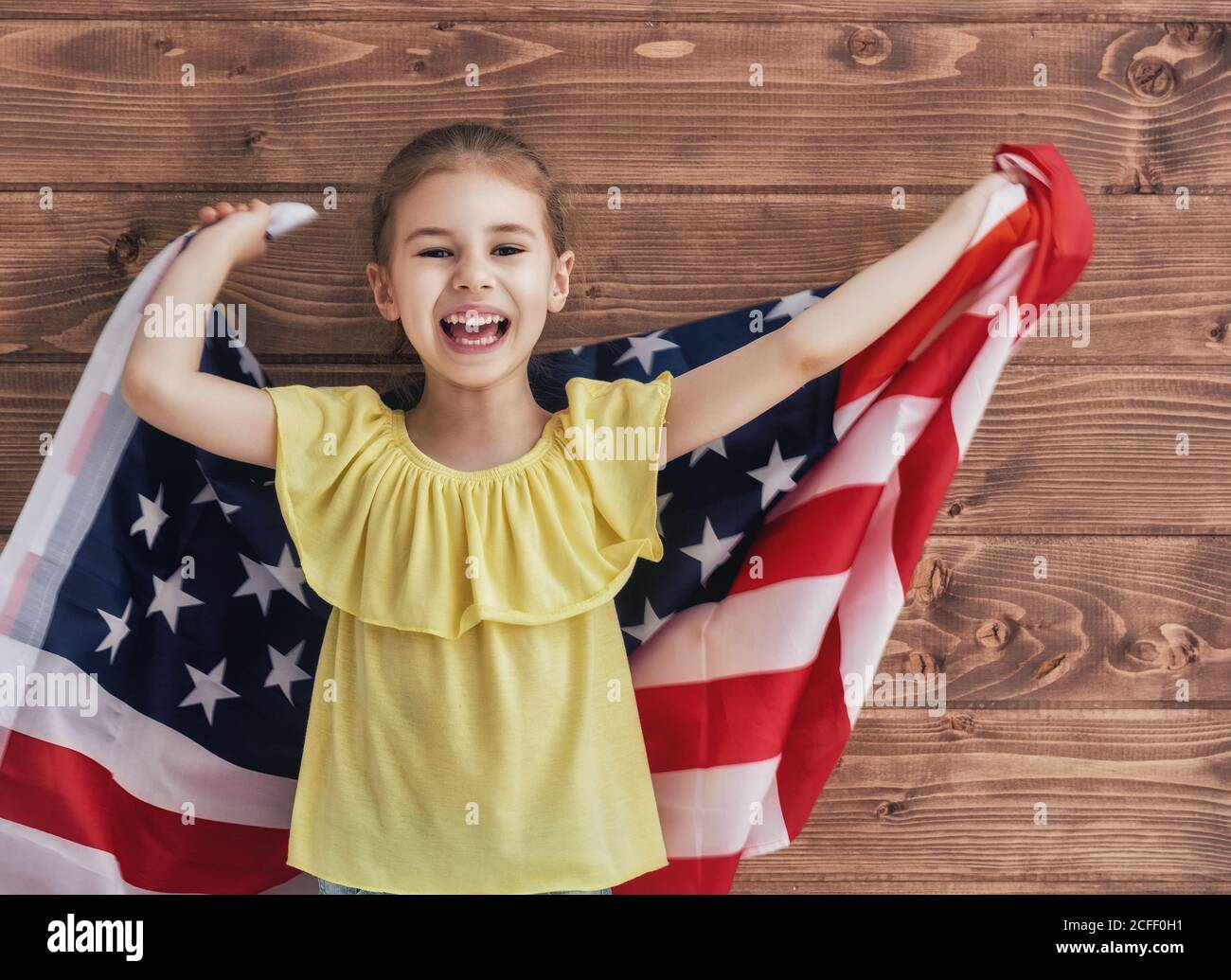Patriotic holiday. Happy kid, cute little child girl with American flag ...