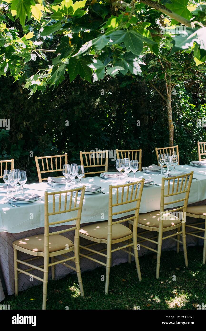 Outdoor rustic celebration table with cutlery and glasses Stock Photo ...