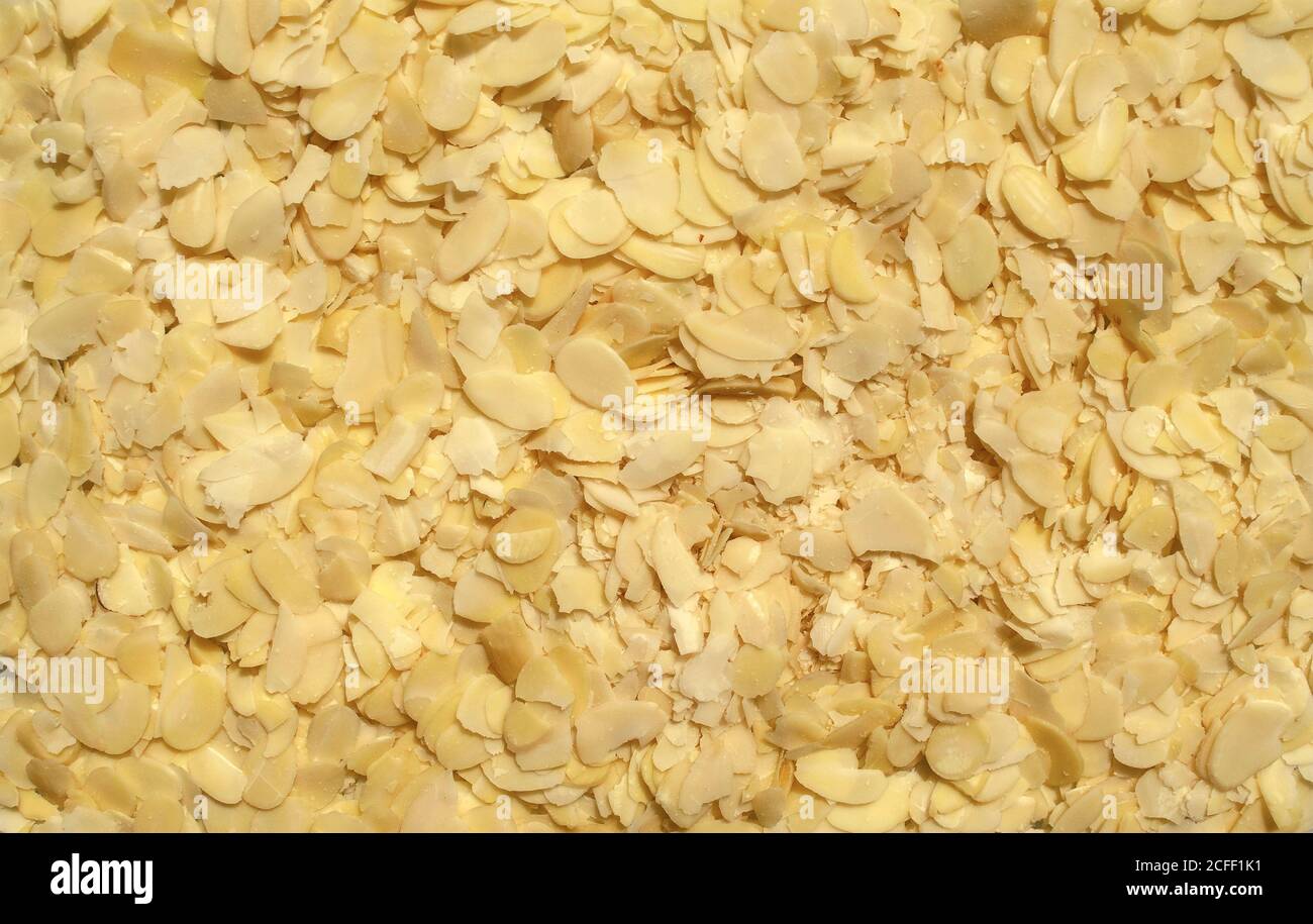 Background made of sliced almond nuts. Healthy snack and food. Top view ...