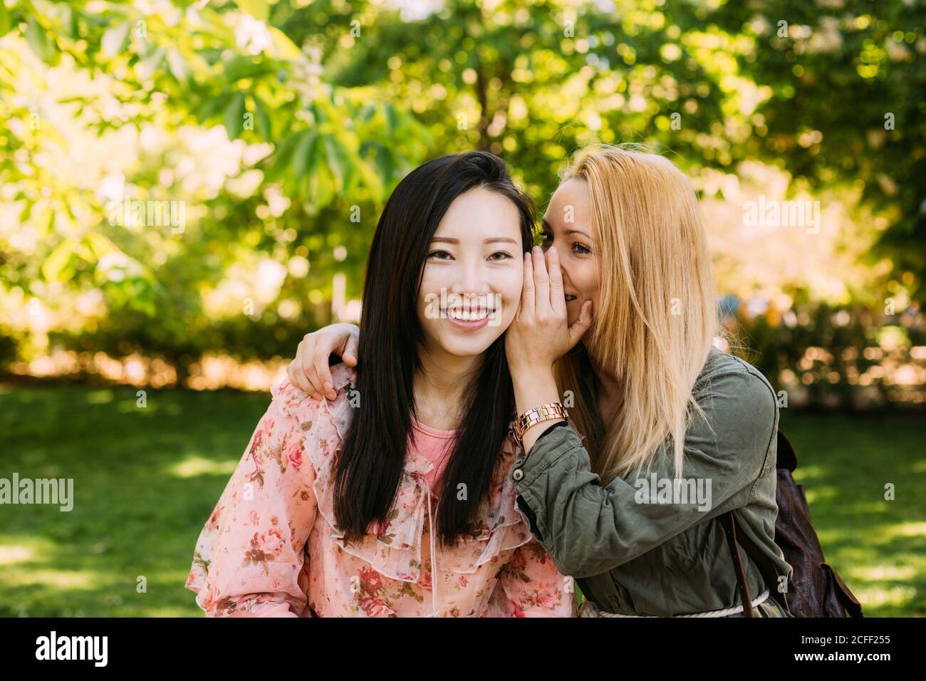 Whispering secret in ear hi-res stock photography and images - Alamy