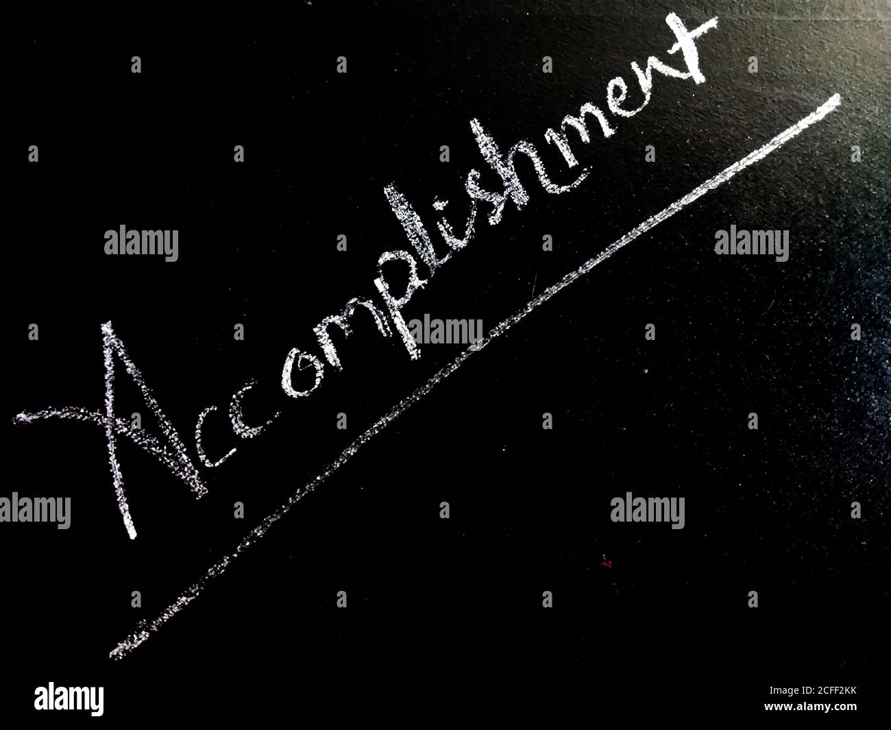 Accomplishment word displayed on black board for learning and awareness ...
