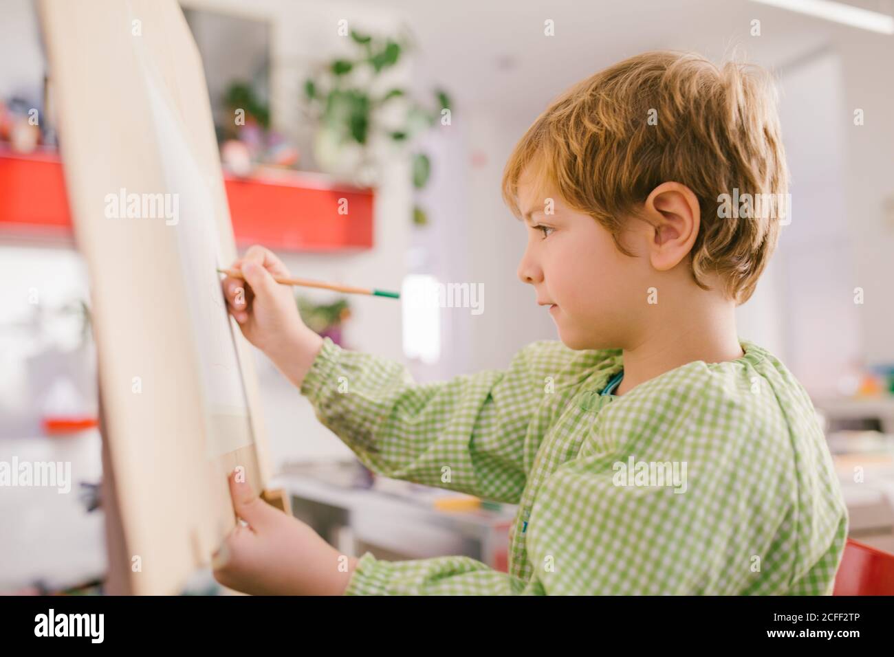 Kid drawing on canvas at home Stock Photo - Alamy