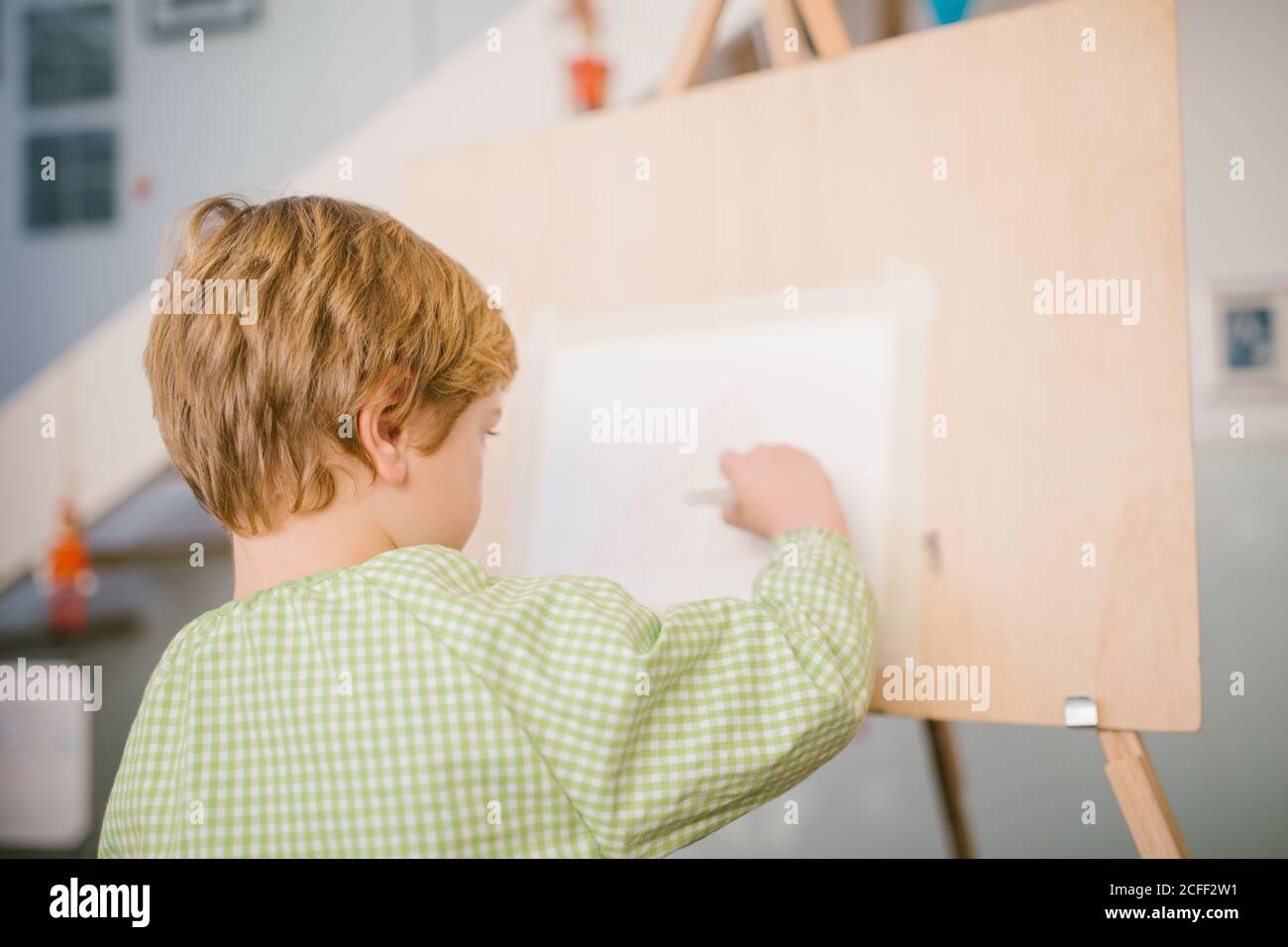 Kid drawing on canvas at home Stock Photo - Alamy