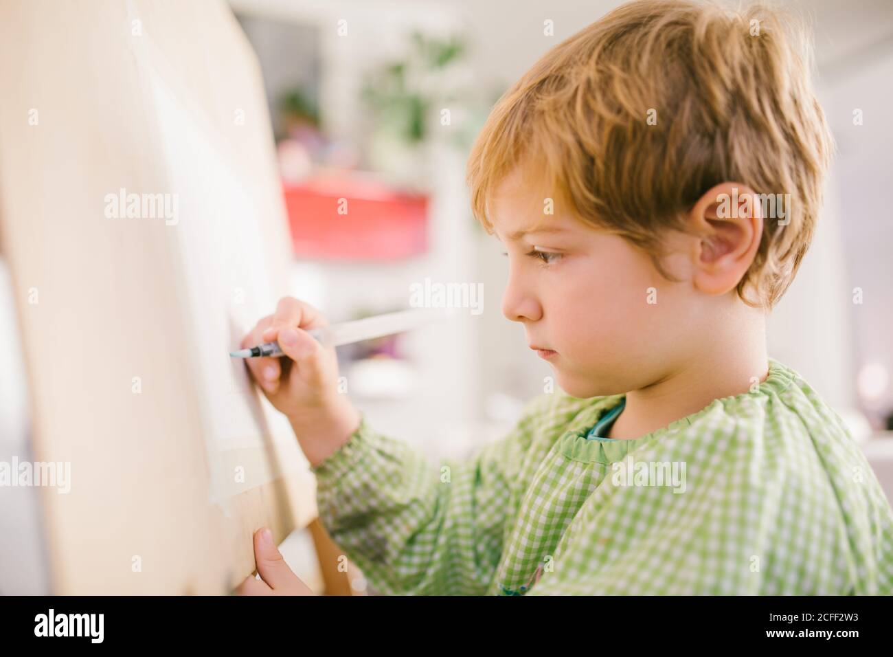 Kid drawing on canvas at home Stock Photo - Alamy