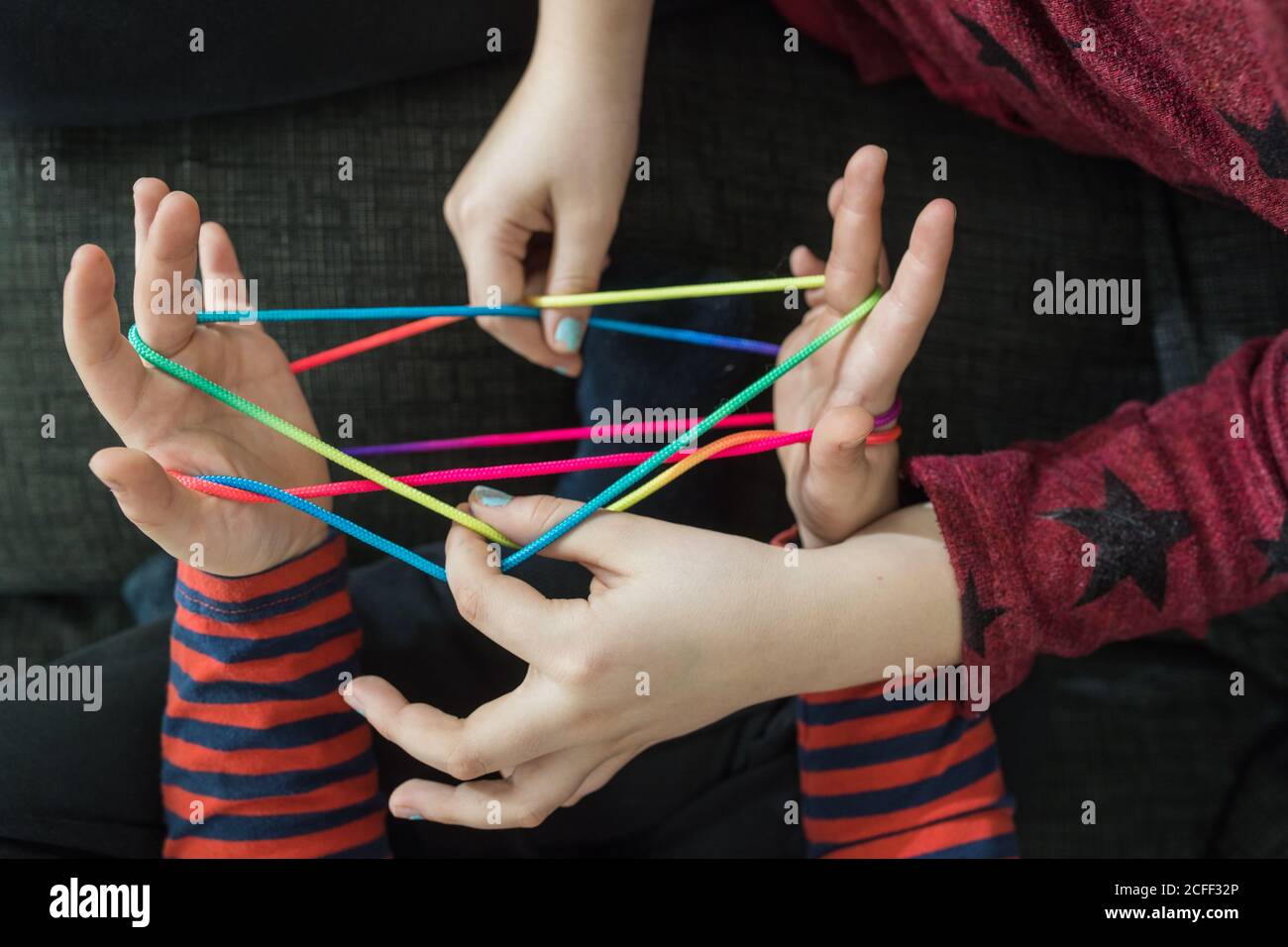 Smart children using rubber bands for game Stock Photo - Alamy