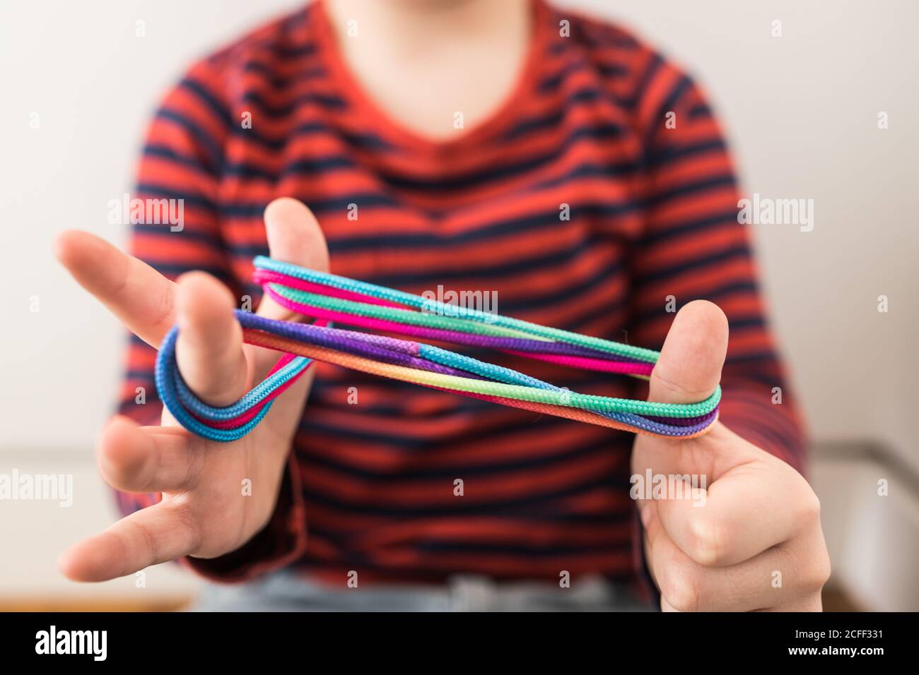Smart kid using rubber bands for game Stock Photo - Alamy