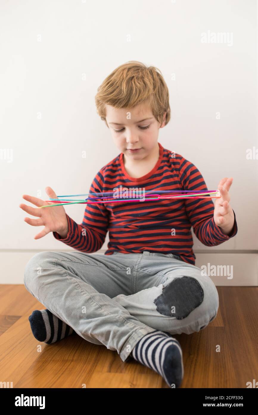 Smart kid using rubber bands for game Stock Photo - Alamy