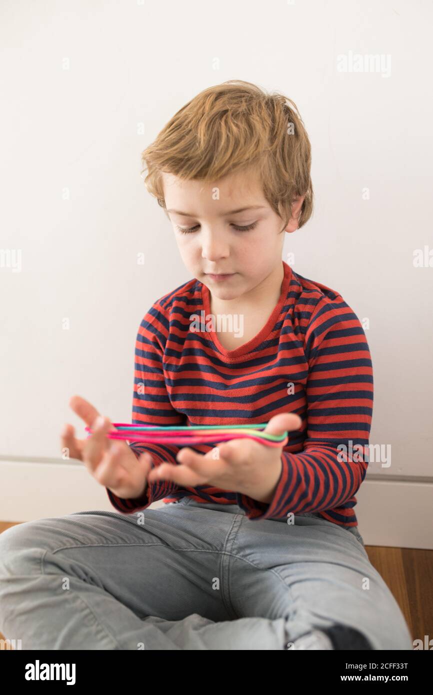Smart kid using rubber bands for game Stock Photo - Alamy
