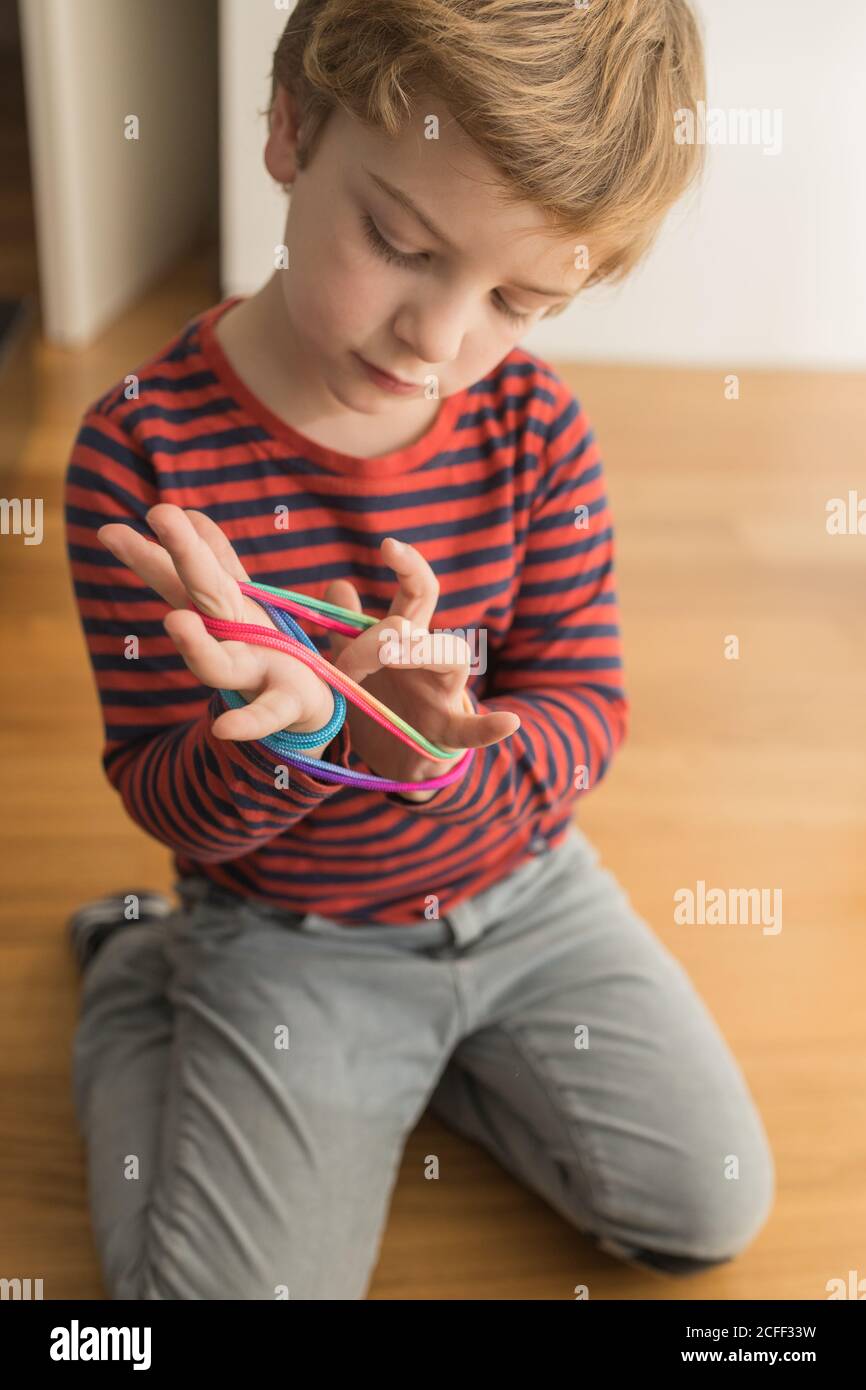 Smart kid using rubber bands for game Stock Photo - Alamy