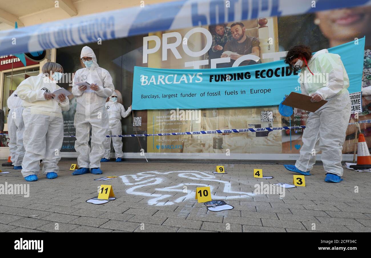 Protesters dressed as forensic investigators outside Barclays bank in ...