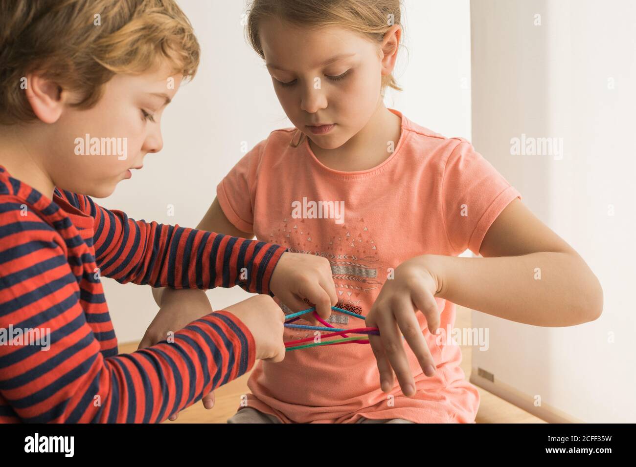 Smart children using rubber bands for game Stock Photo - Alamy