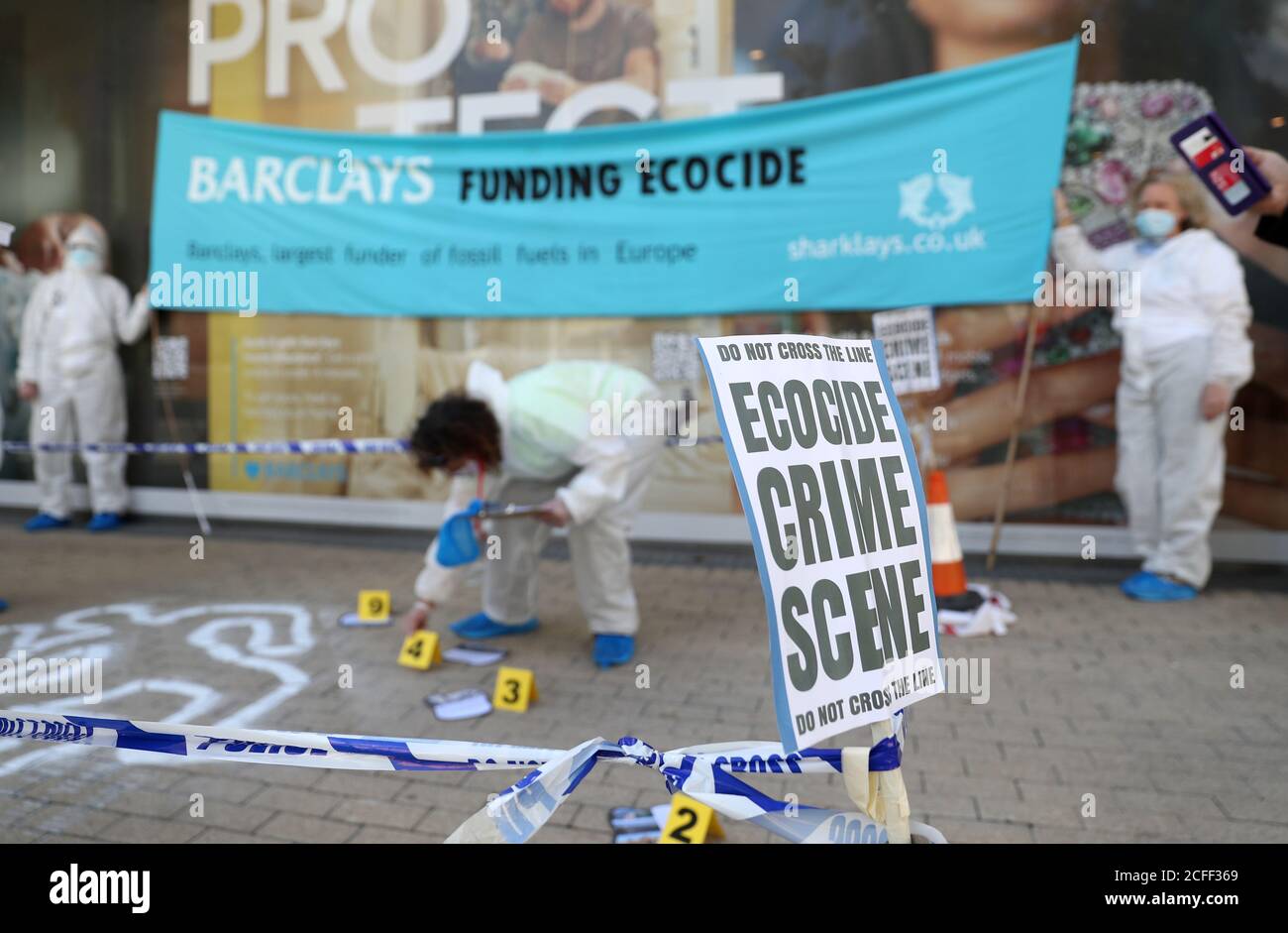 Protesters dressed as forensic investigators outside Barclays bank in ...
