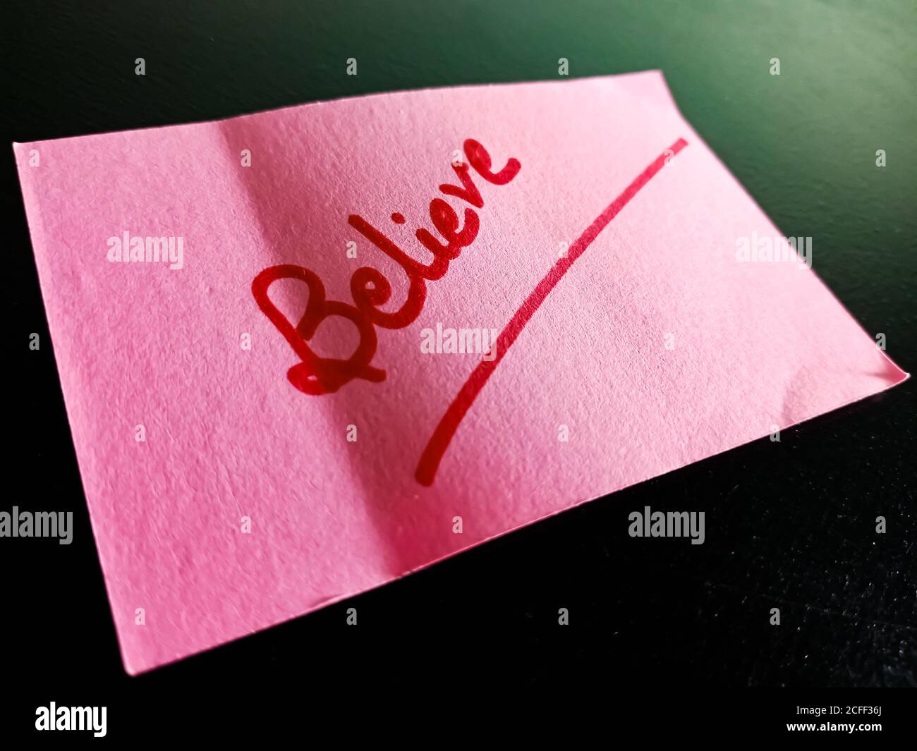Believe word displayed on paper slip concept for educational ...