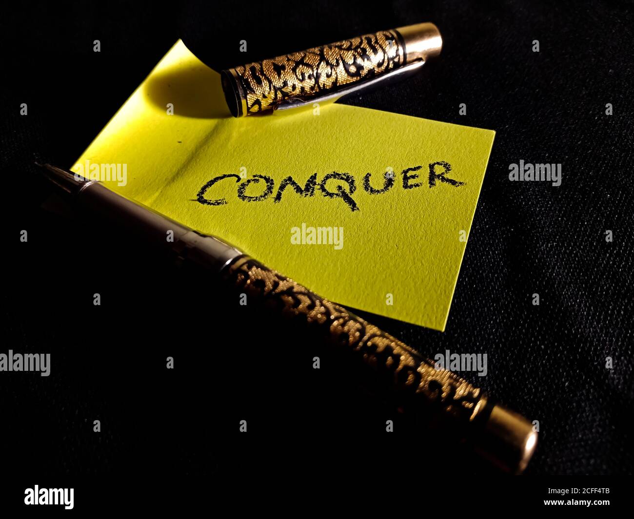 Conquer word displayed on paper slip concept for educational ...