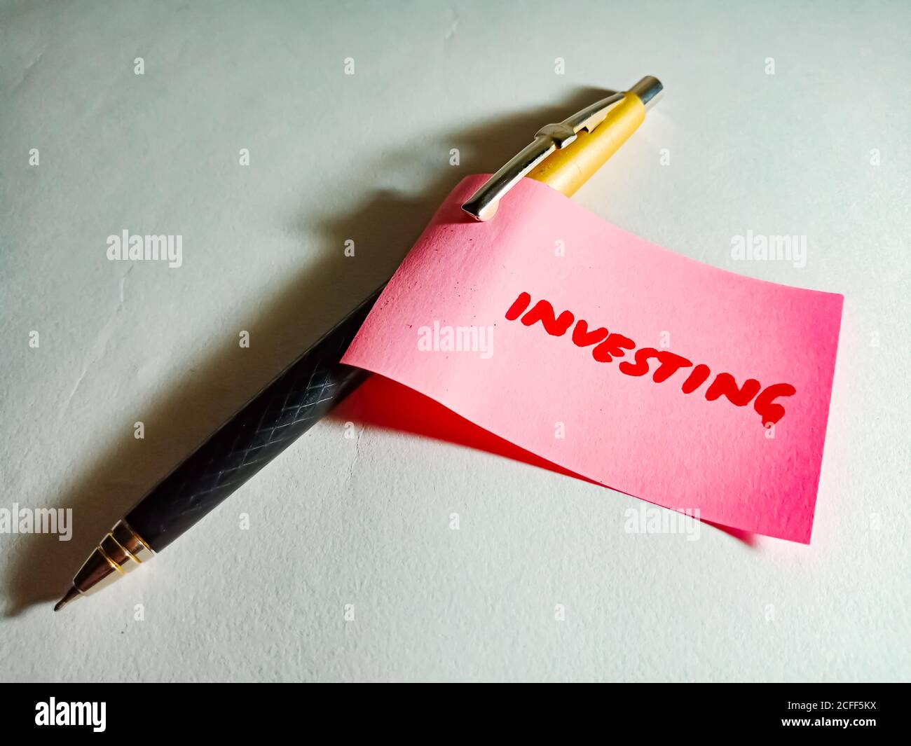 Investing word displayed on paper slip concept for educational ...