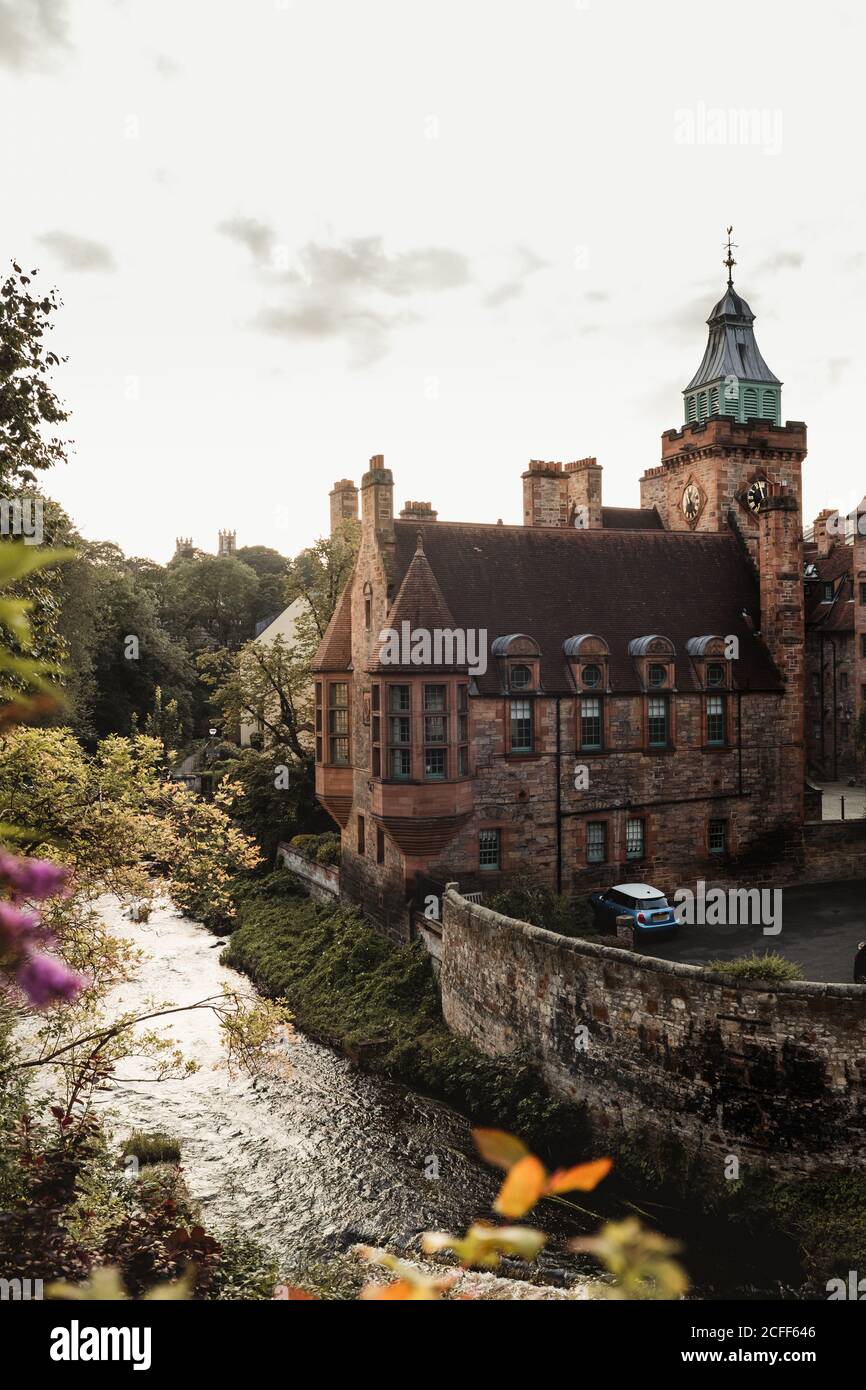 Amazing landscape with medieval brick building along small river and ...
