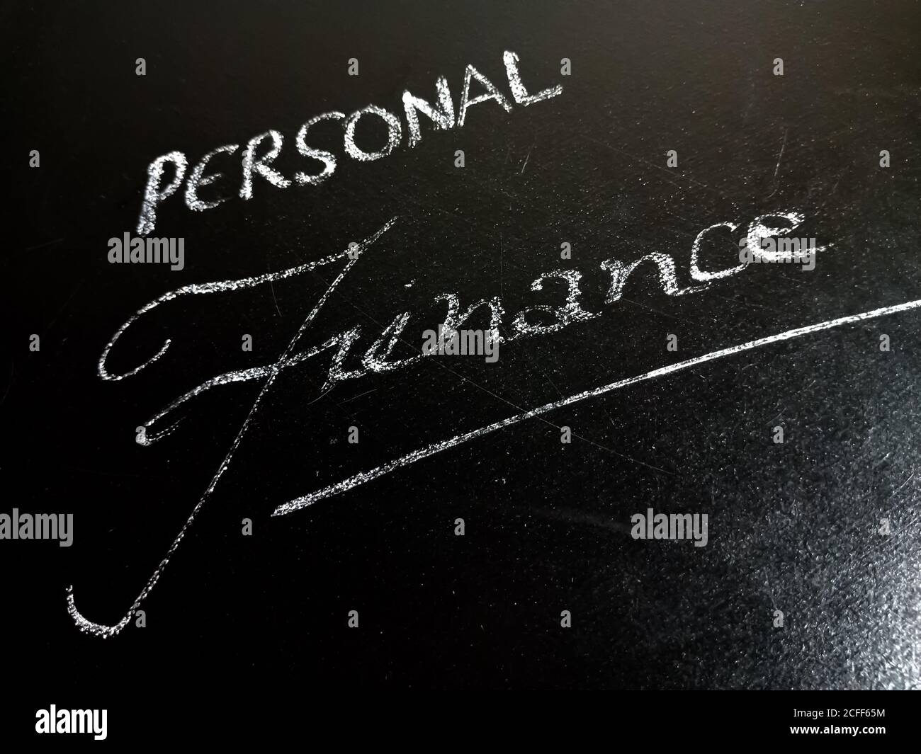 Personal Finance word displayed on chalkboard for learning and ...