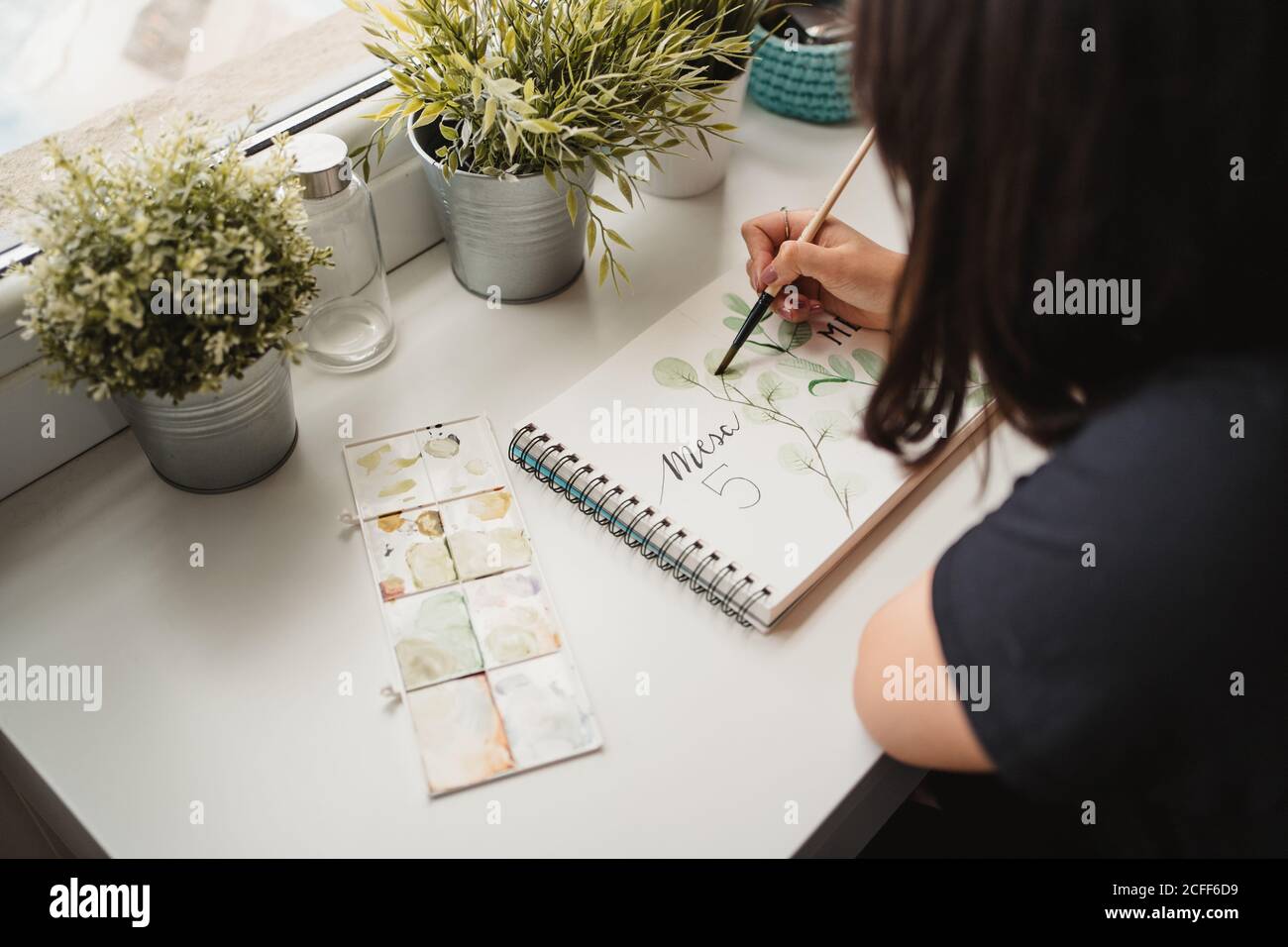 Crop from above view of unrecognizable Woman drawing picture with ...