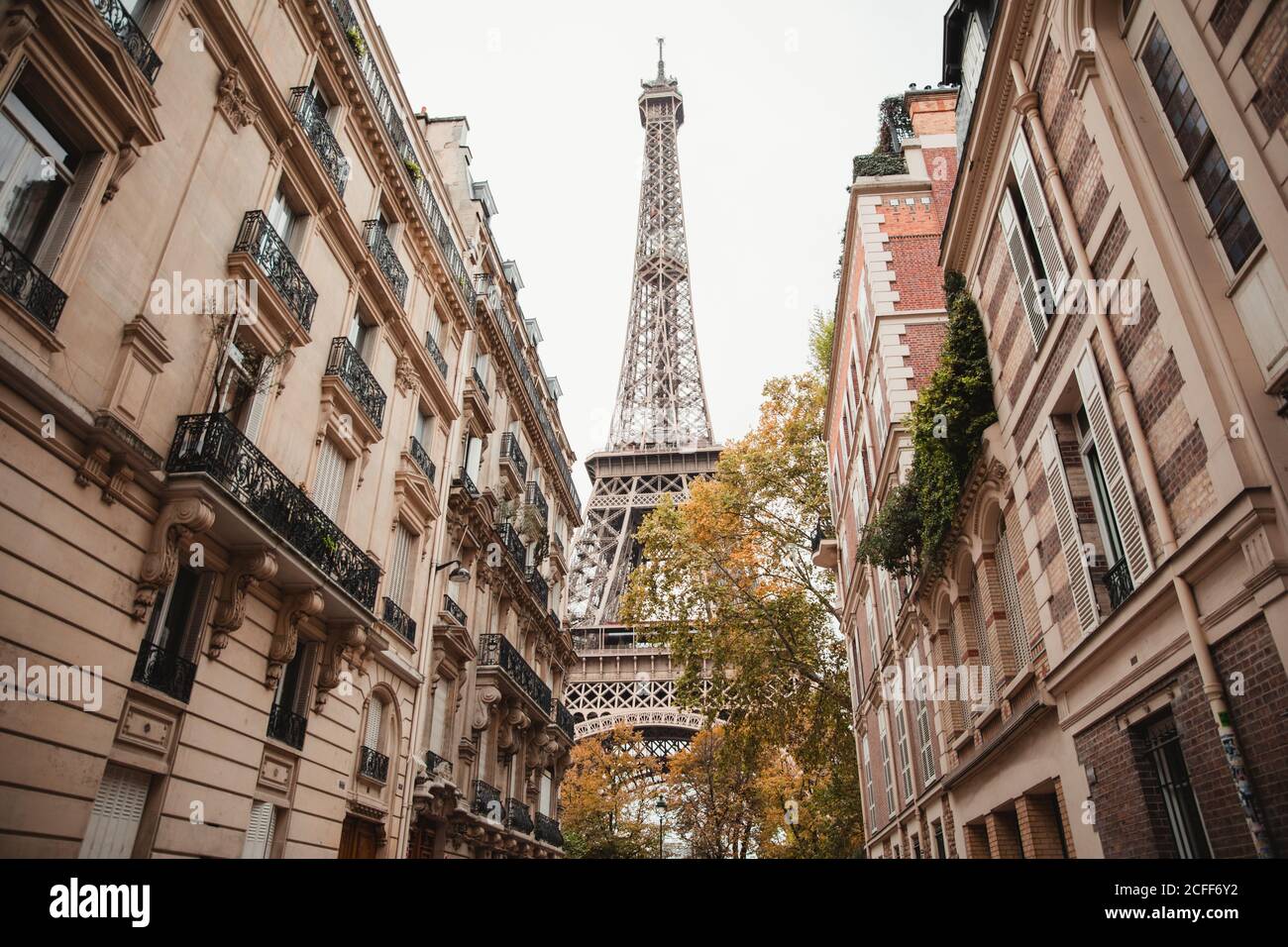 View of Eiffel Tower and old buildings of Paris from street of France ...