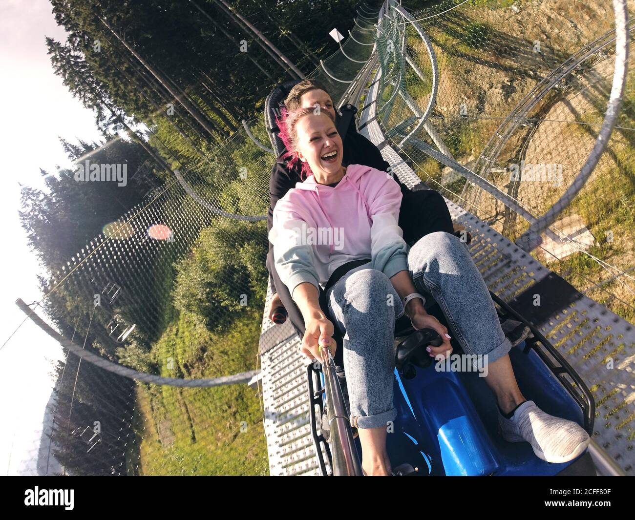 Summer toboggan run rodelbahn with many curves on a mountain. Alpine ...