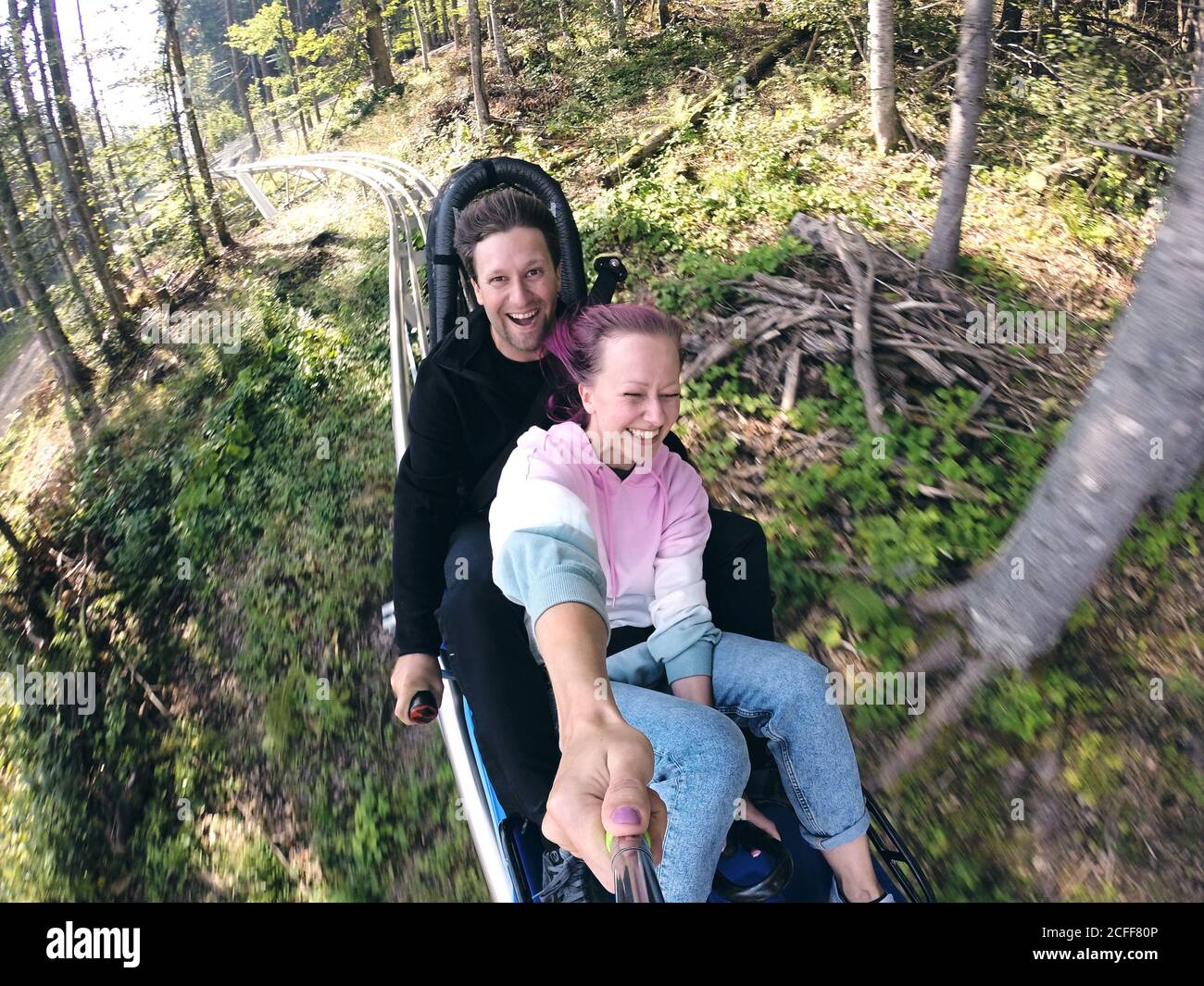 Summer toboggan run rodelbahn with many curves on a mountain. Alpine ...