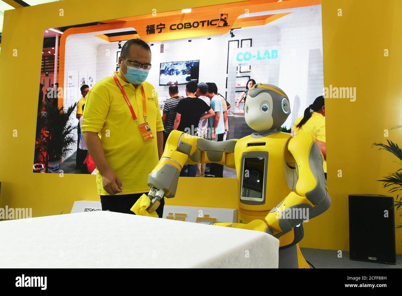 Beijing, China. 5th Sep, 2020. A staff shows a smart home service robot ...